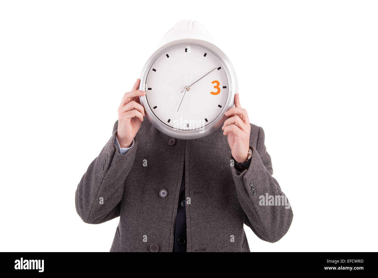 Engineer dressed for winter holding a clock Stock Photo - Alamy