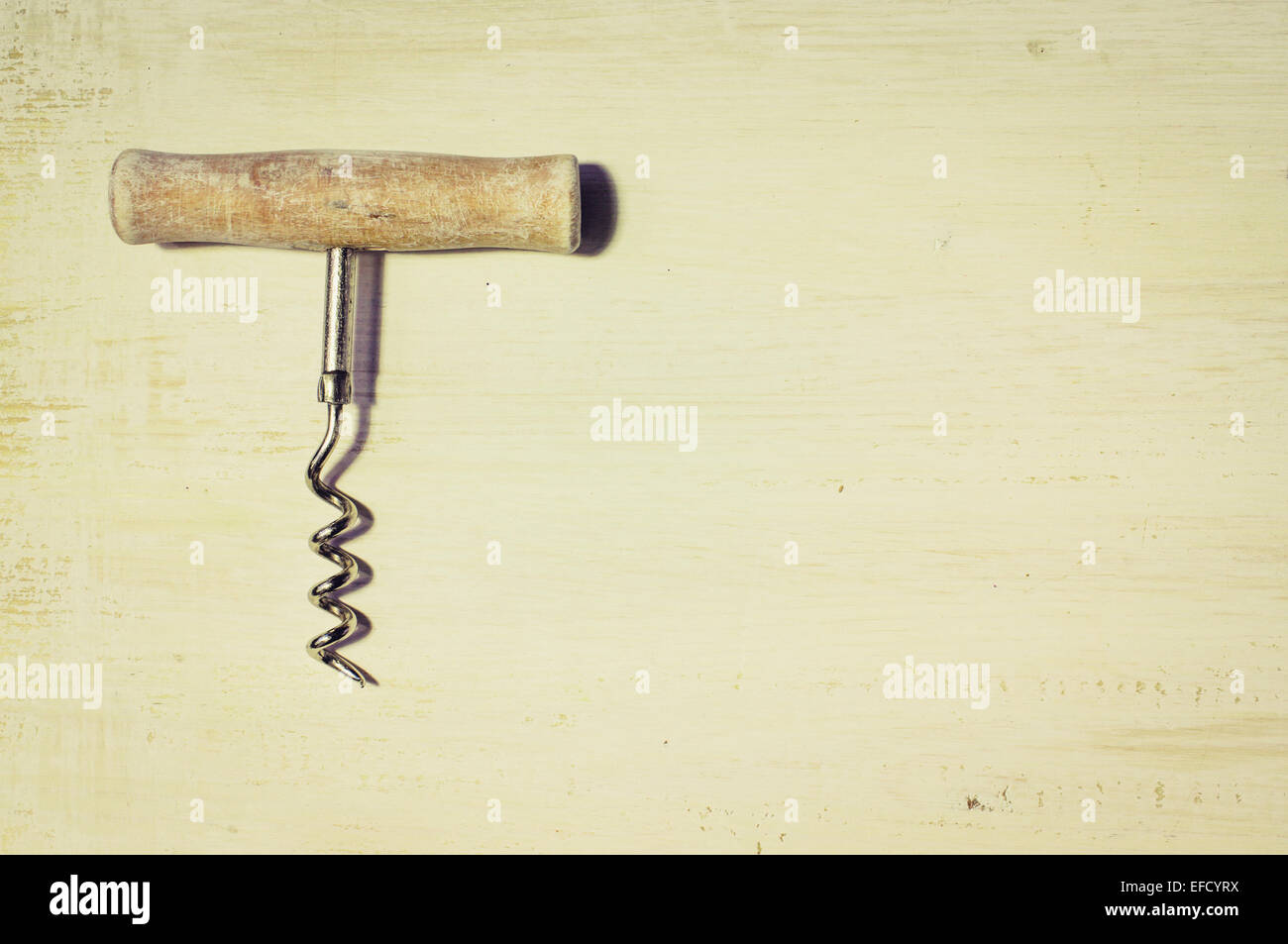 Vintage corkscrew on the old board for background Stock Photo - Alamy