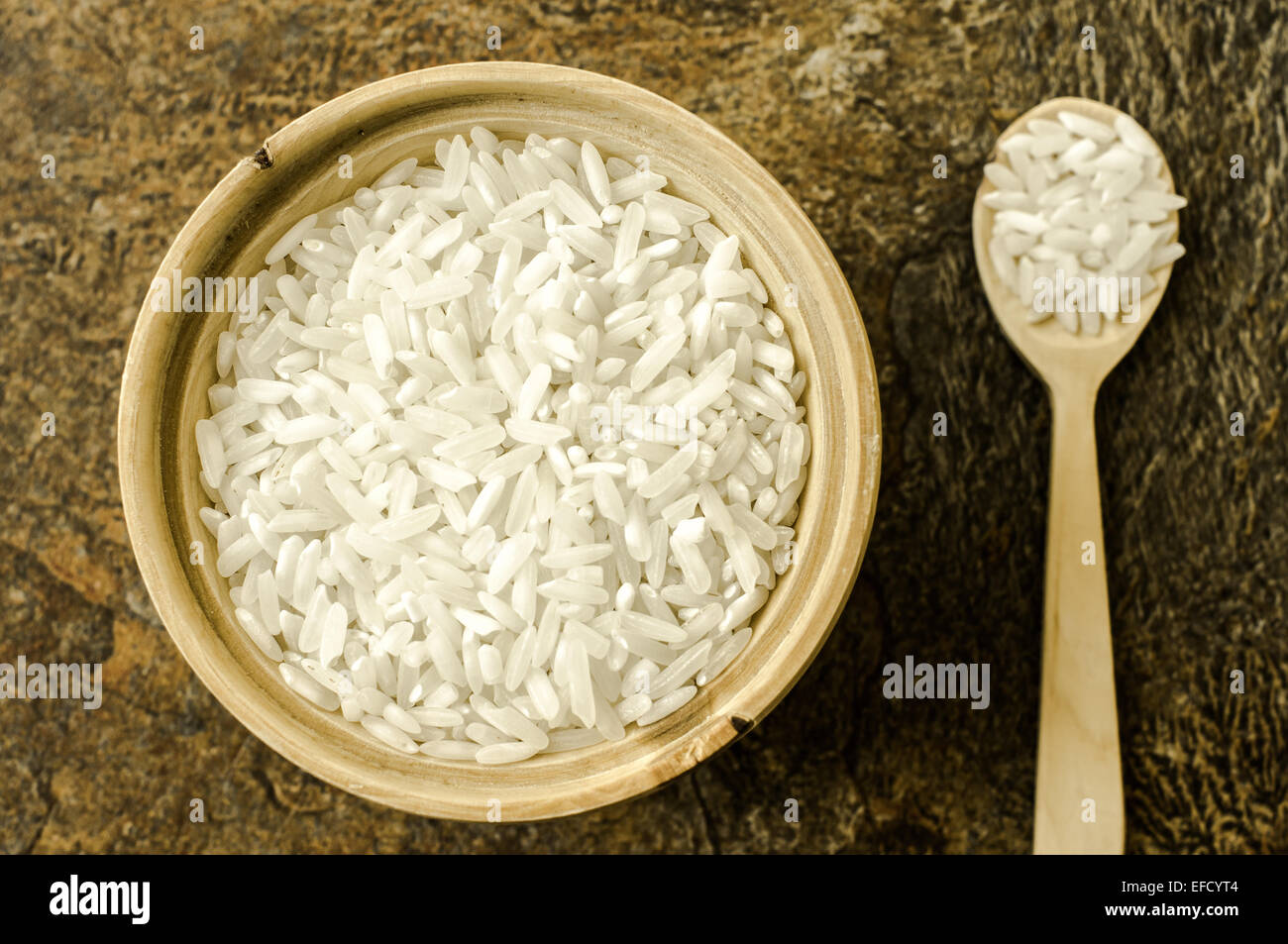 Long grain rice in a wooden bowl, top view Stock Photo - Alamy