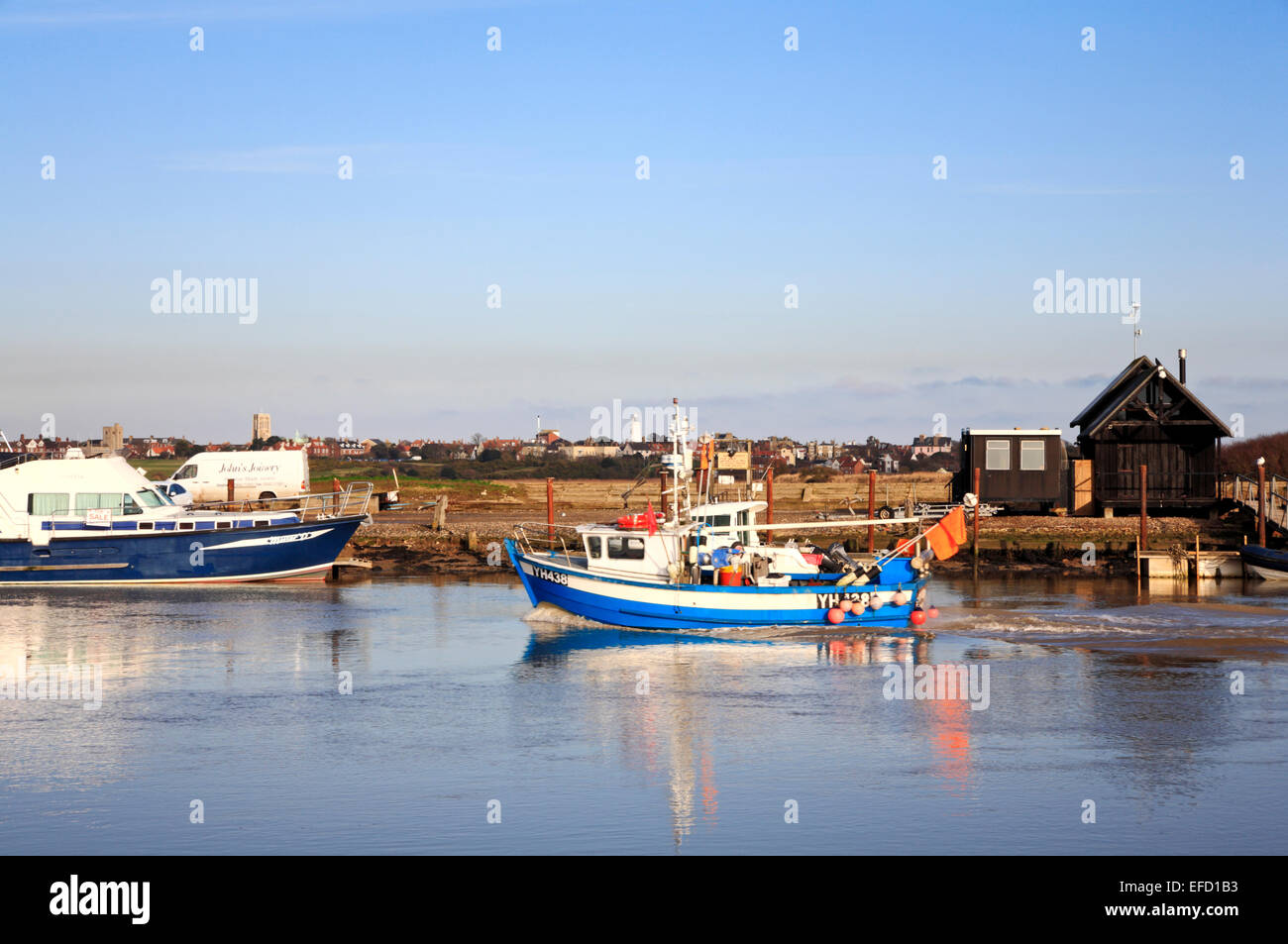 An inshore fishing boat returning up the River Blyth to the harbour at ...
