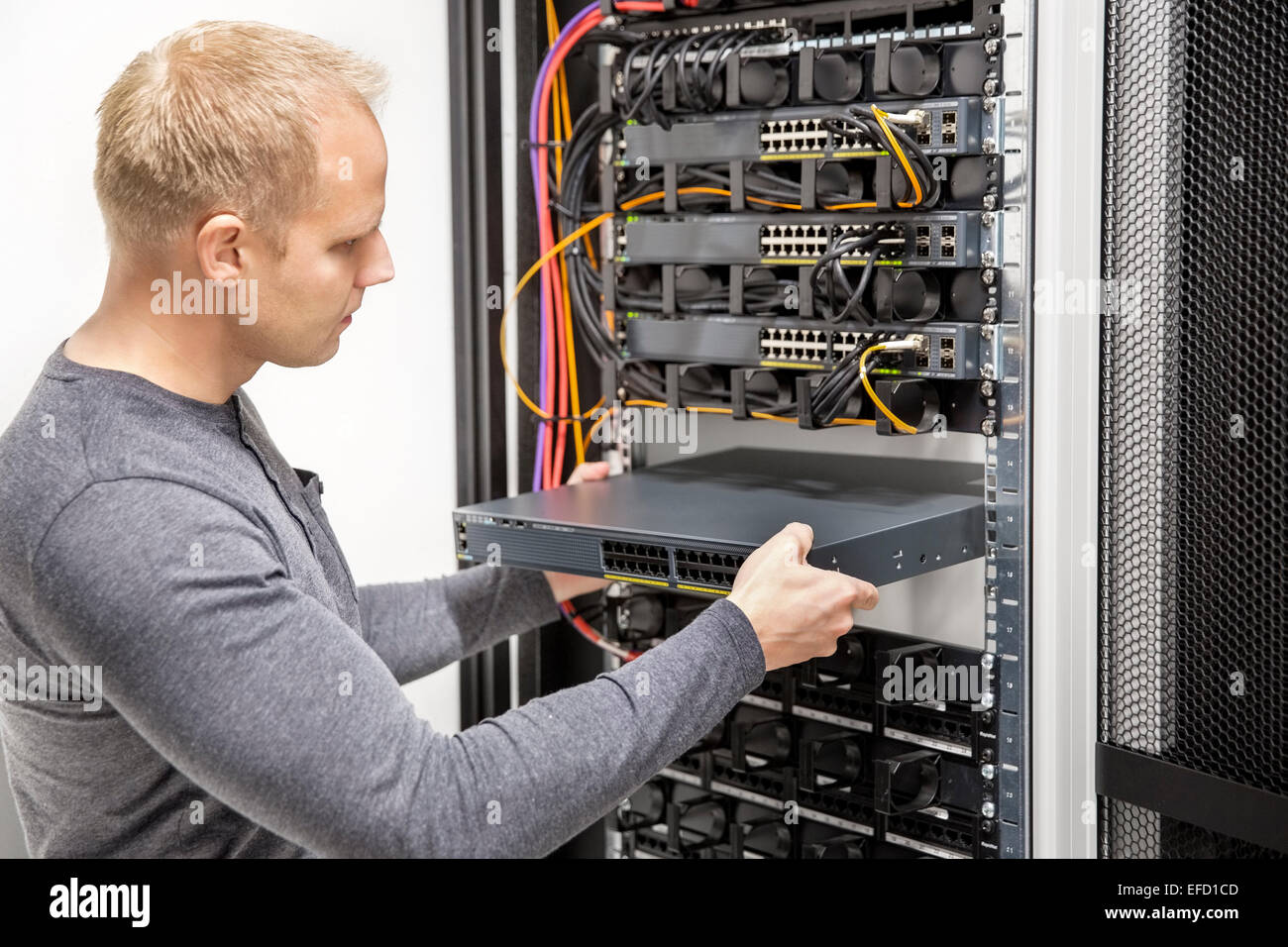 IT consultant build network racks in datacenter Stock Photo - Alamy