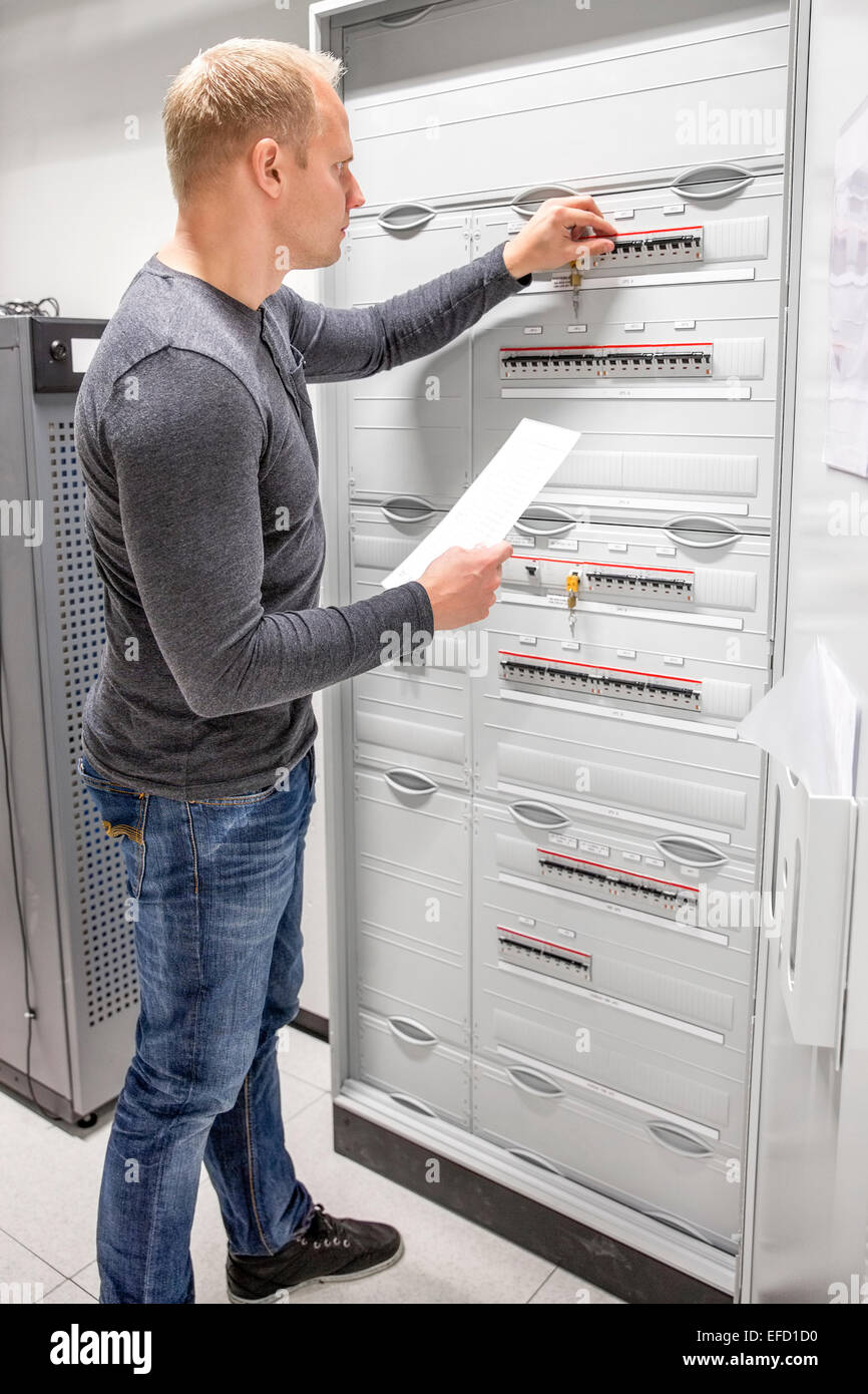 IT engineer works in large fuse cabinet Stock Photo - Alamy