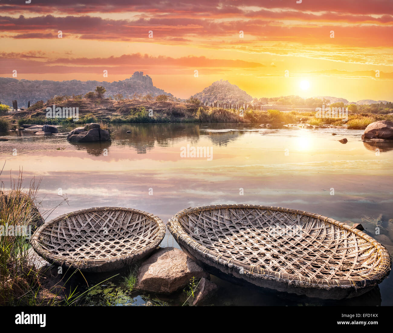 Round shape boats on Tungabhadra river at sunset sky in Hampi ...