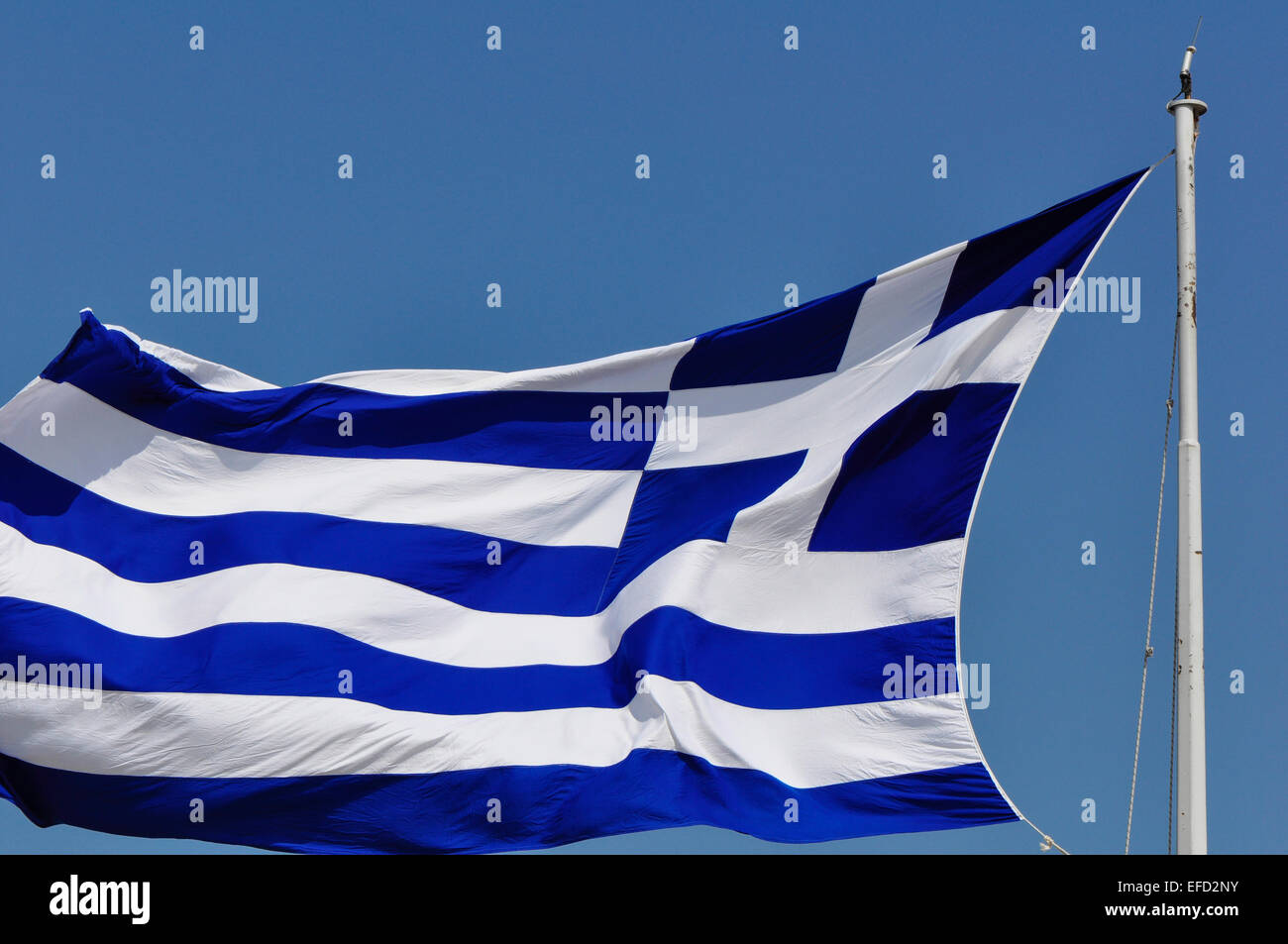 National flag of Greece flying in a blue background Stock Photo - Alamy