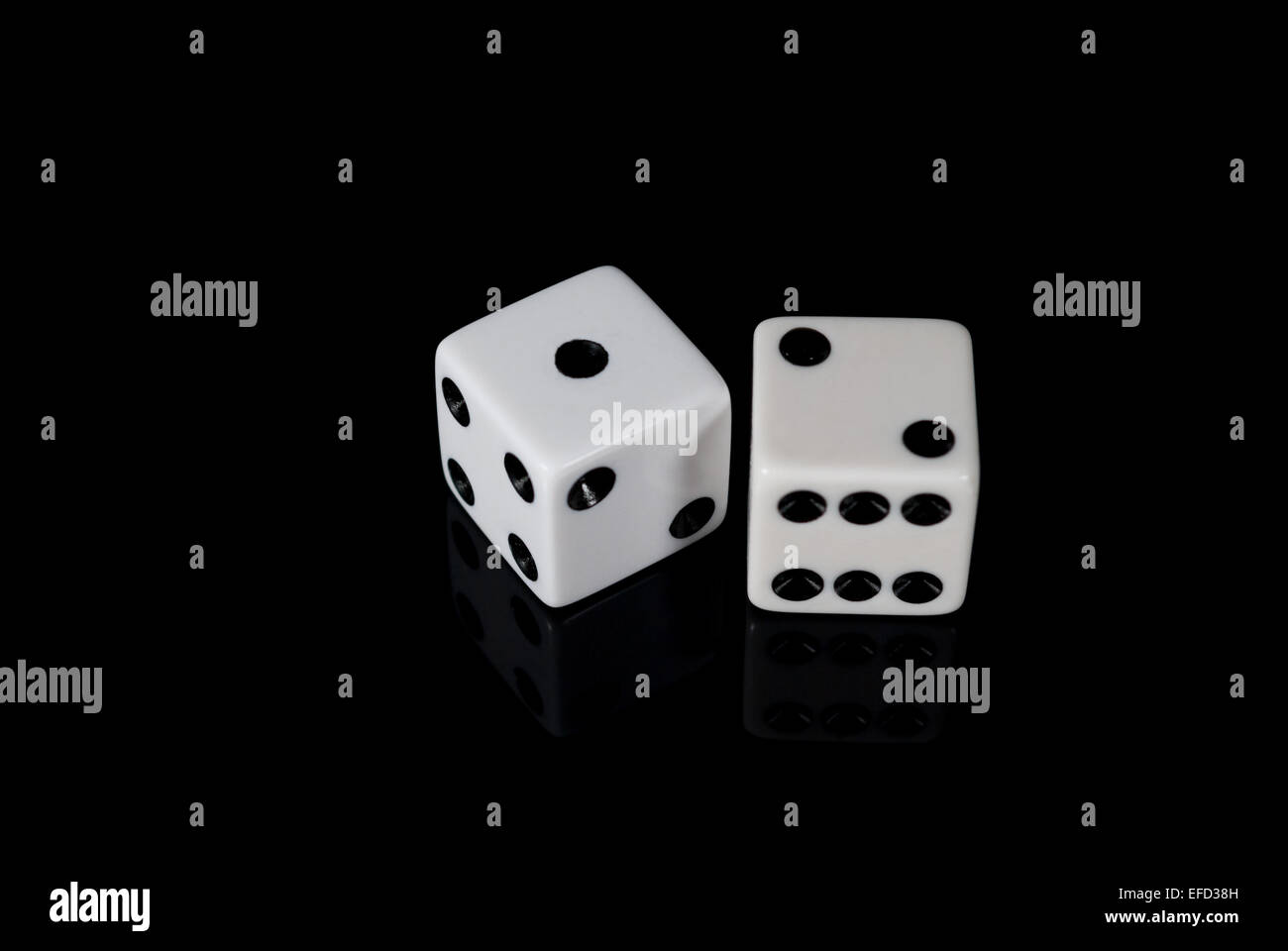 Two white dice on black reflect background Stock Photo - Alamy