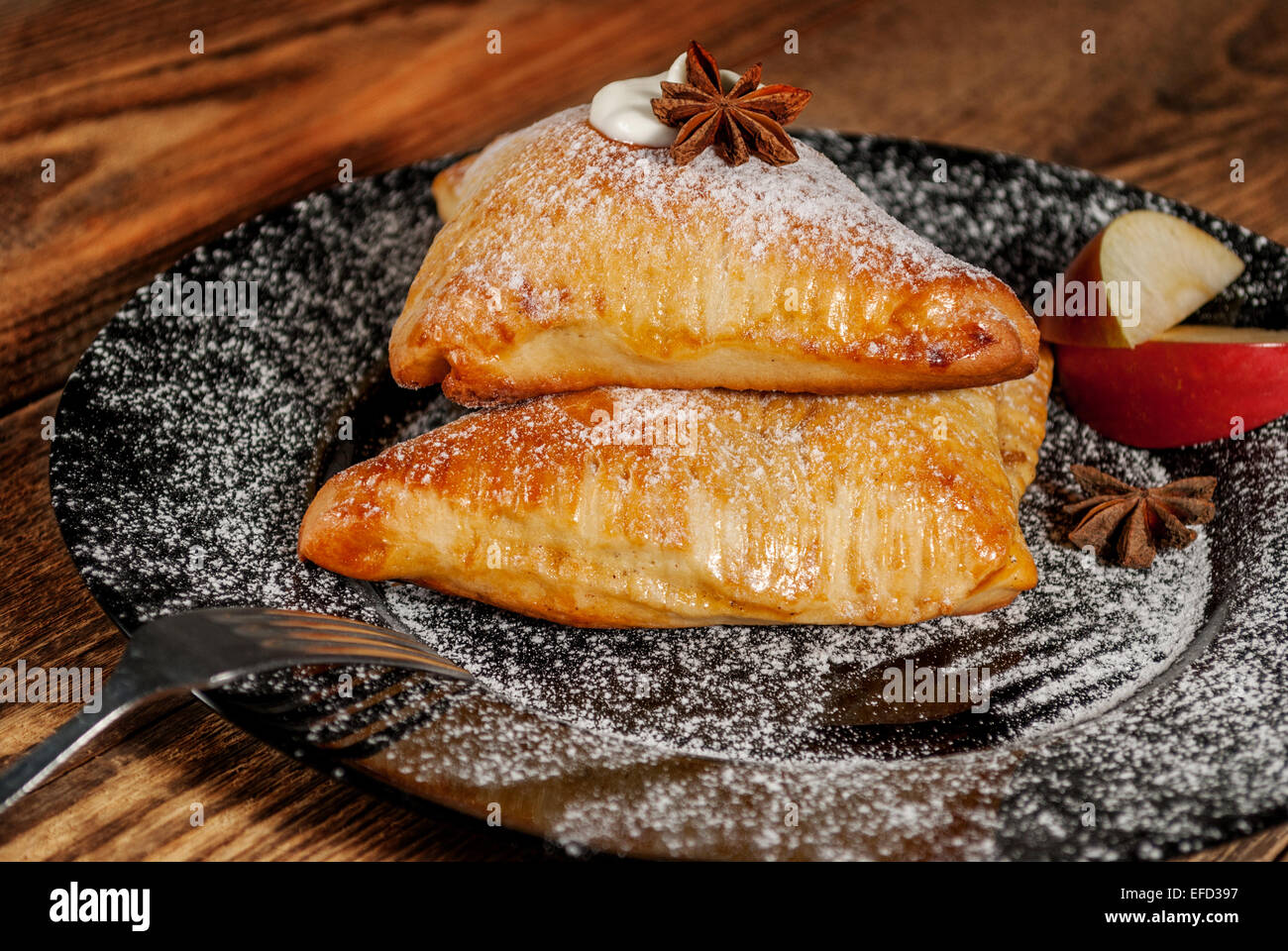 Apple dessert on black plate on wood table Stock Photo - Alamy