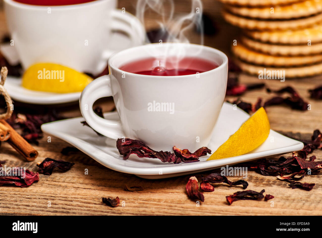 Cup of tea with hibiscus and lemon and cinnamon on wood table Stock ...