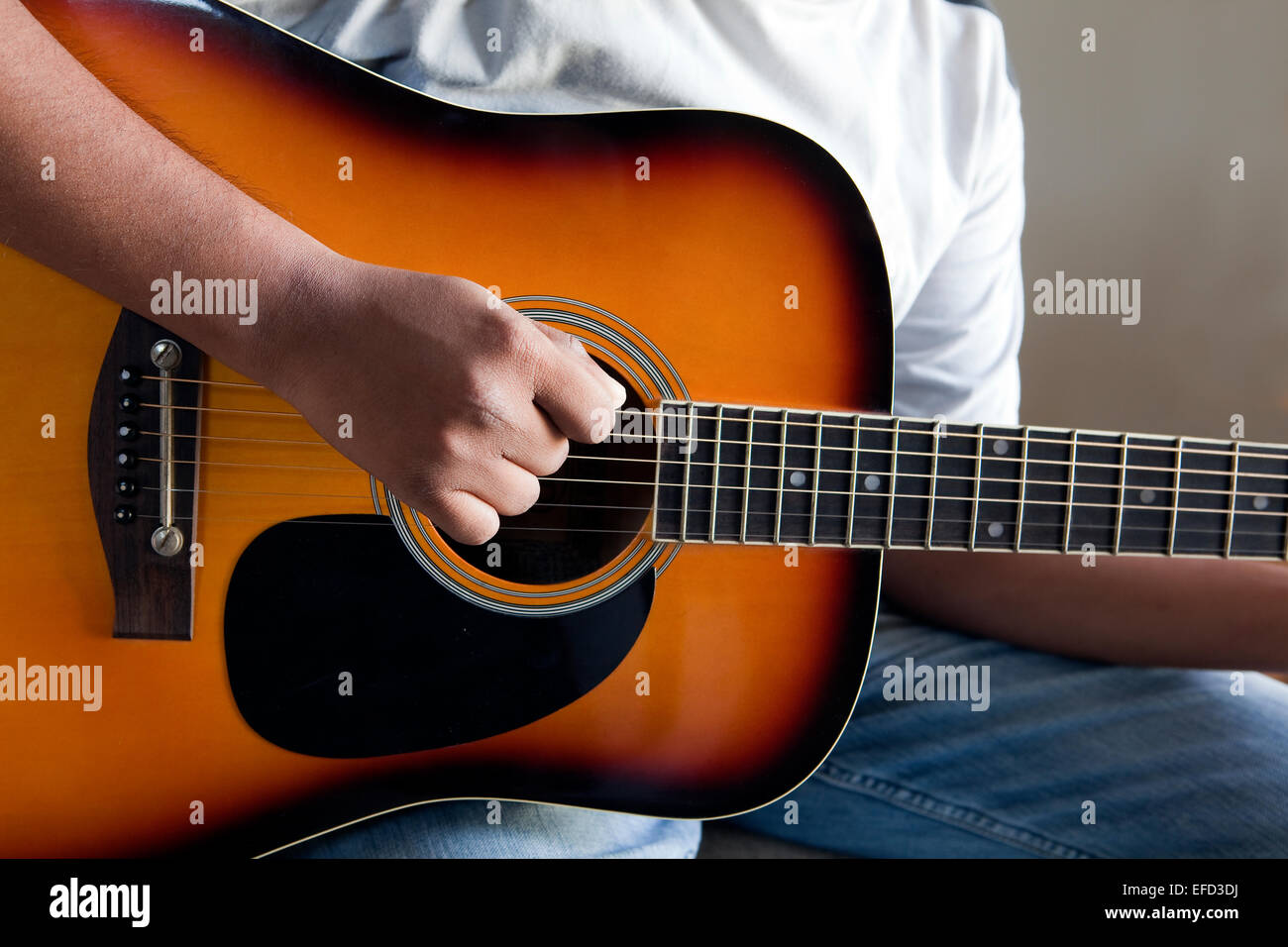 closeup view of right hand strumming an acoustic guitar Stock Photo - Alamy