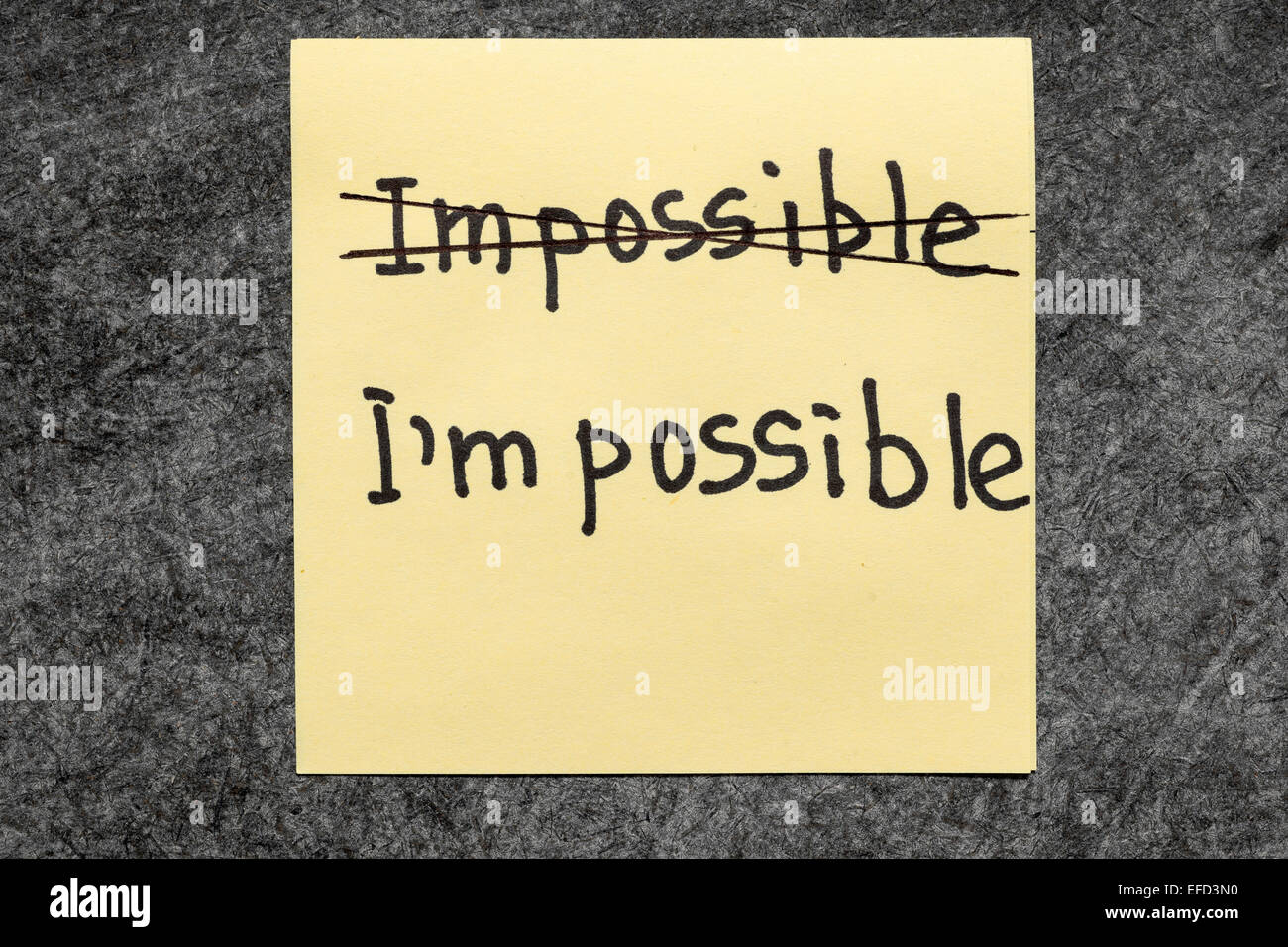 impossible - I am possible concept handwritten on yellow paper note ...