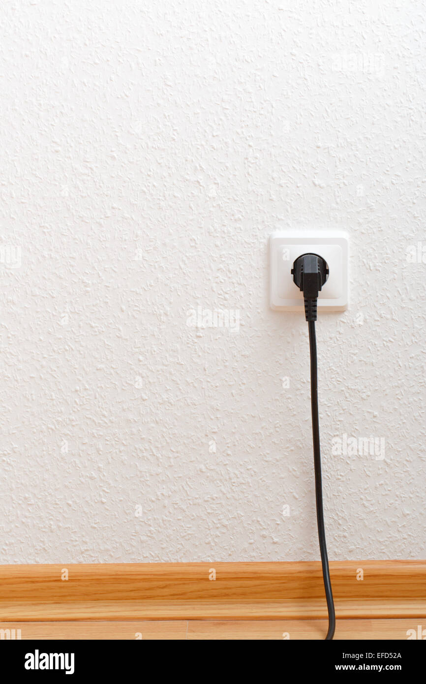 Single electric socket with plug on white wall Stock Photo - Alamy