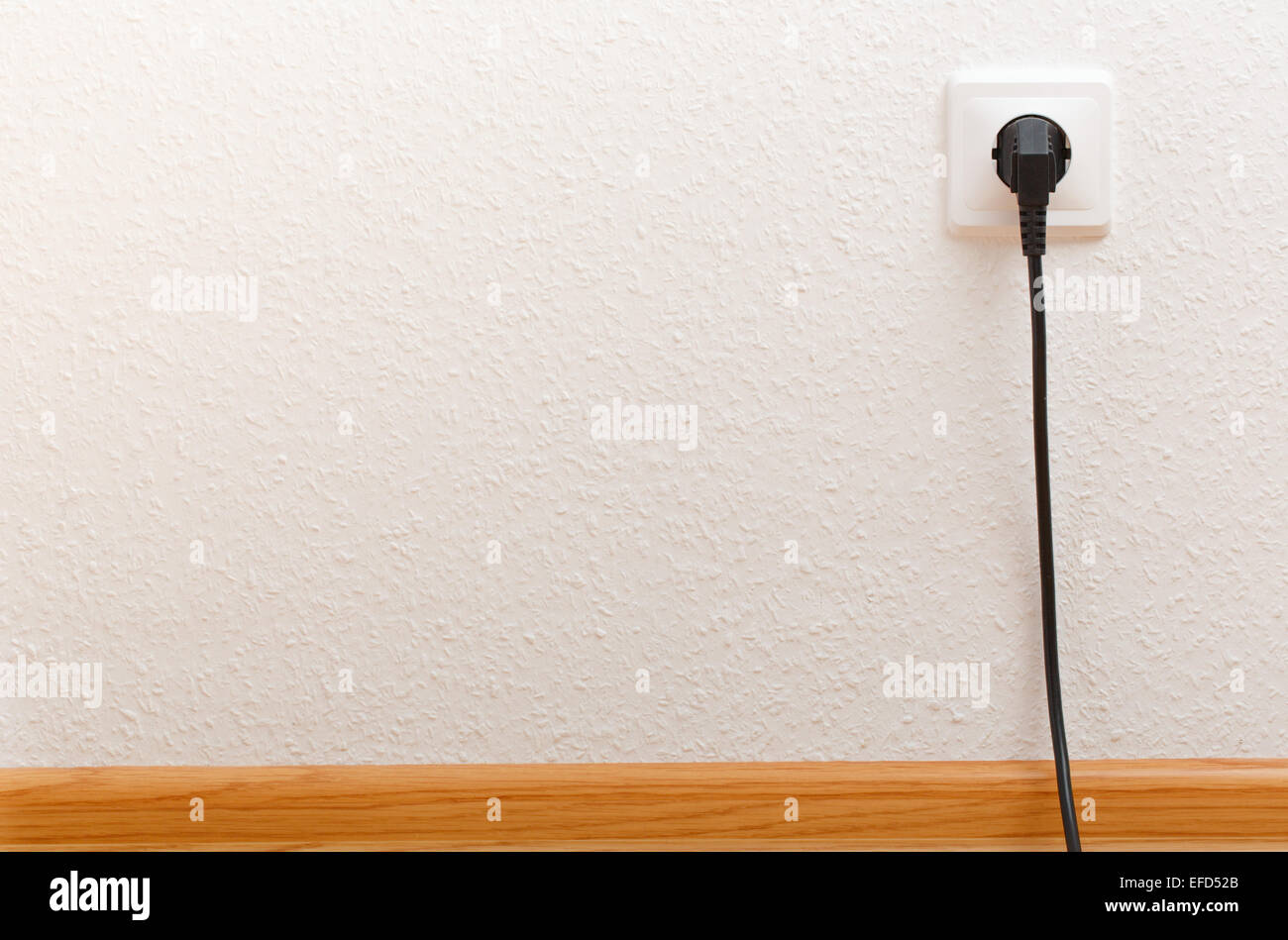 Single electric socket with plug on white wall Stock Photo - Alamy