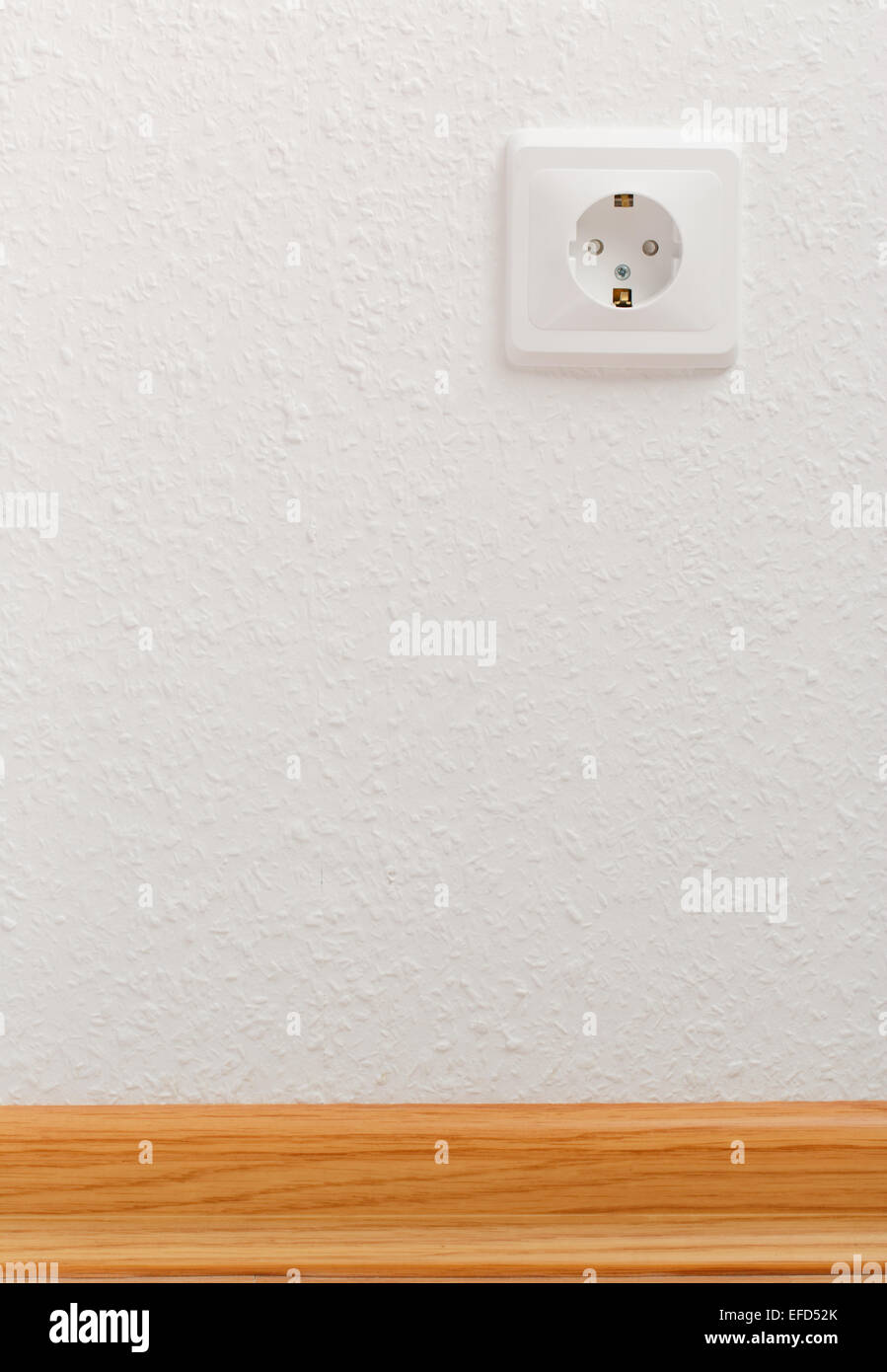 Single empty electric socket on white wall Stock Photo - Alamy