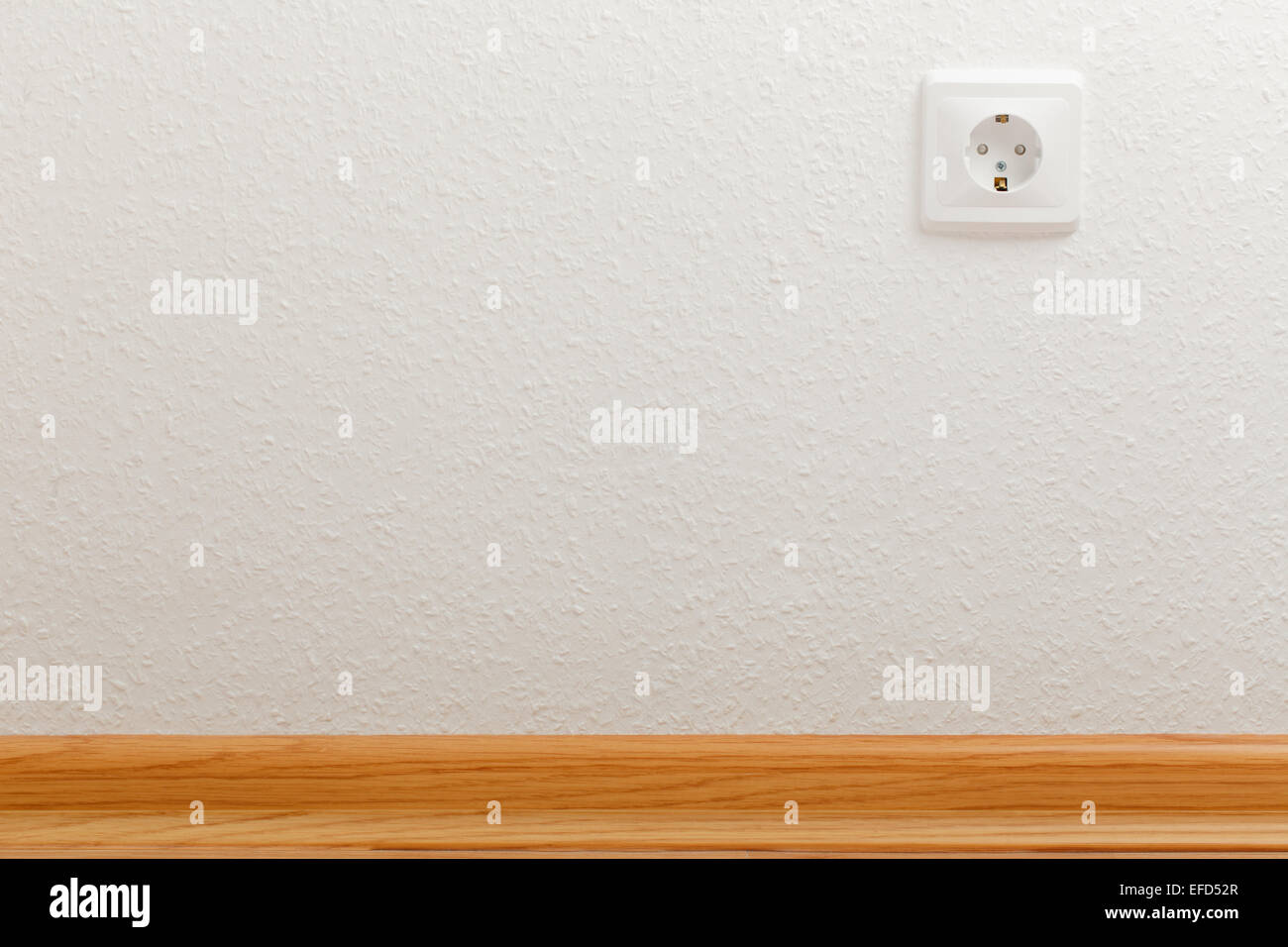 Single empty electric socket on white wall Stock Photo - Alamy