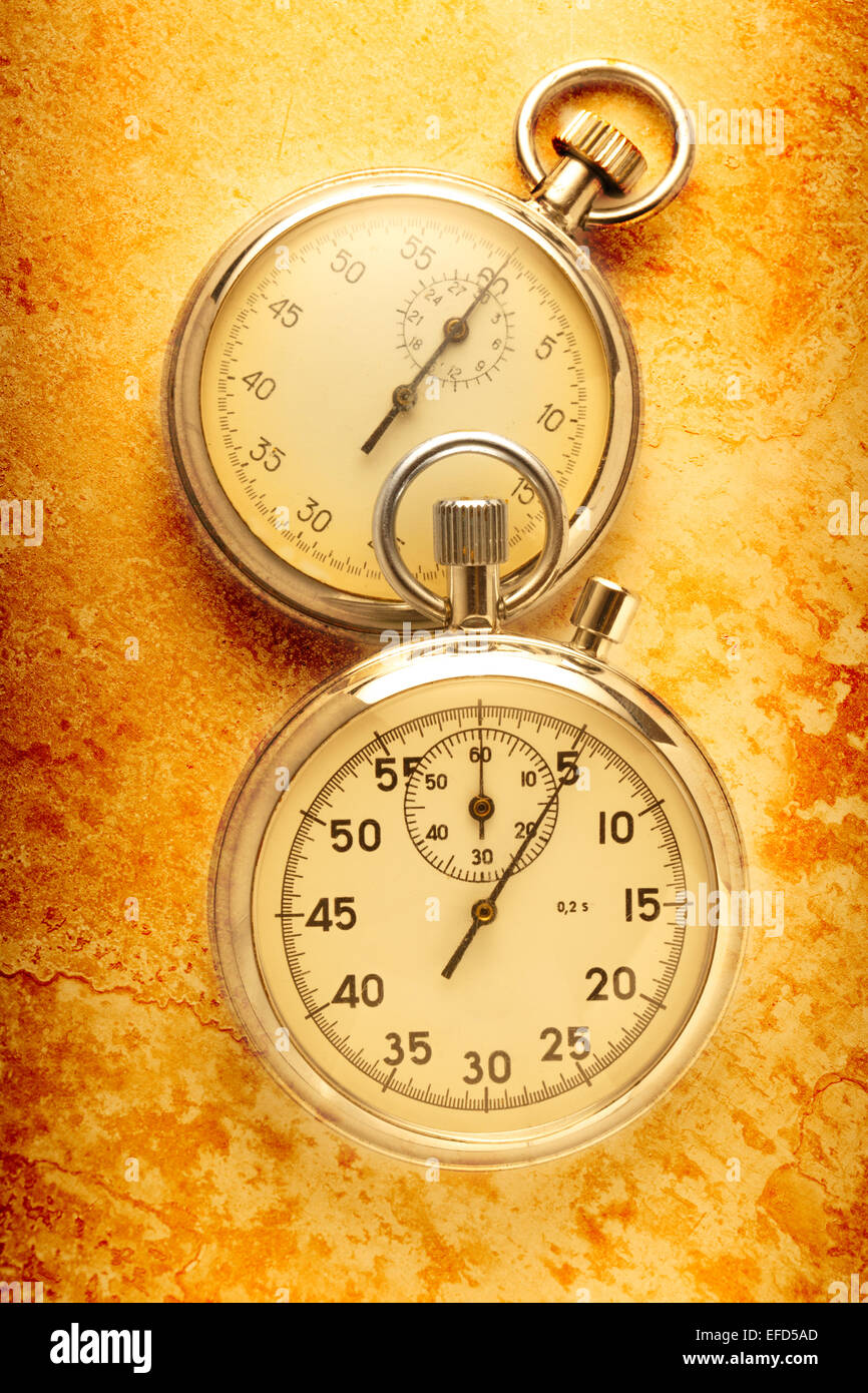 Two stopwatches on textured background in toning Stock Photo - Alamy