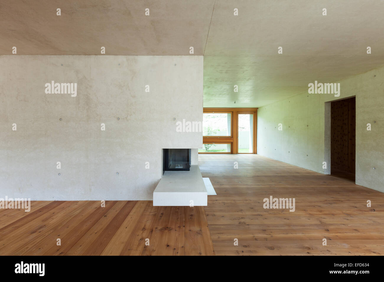 new apartment in cement and wood,room with fireplace Stock Photo - Alamy