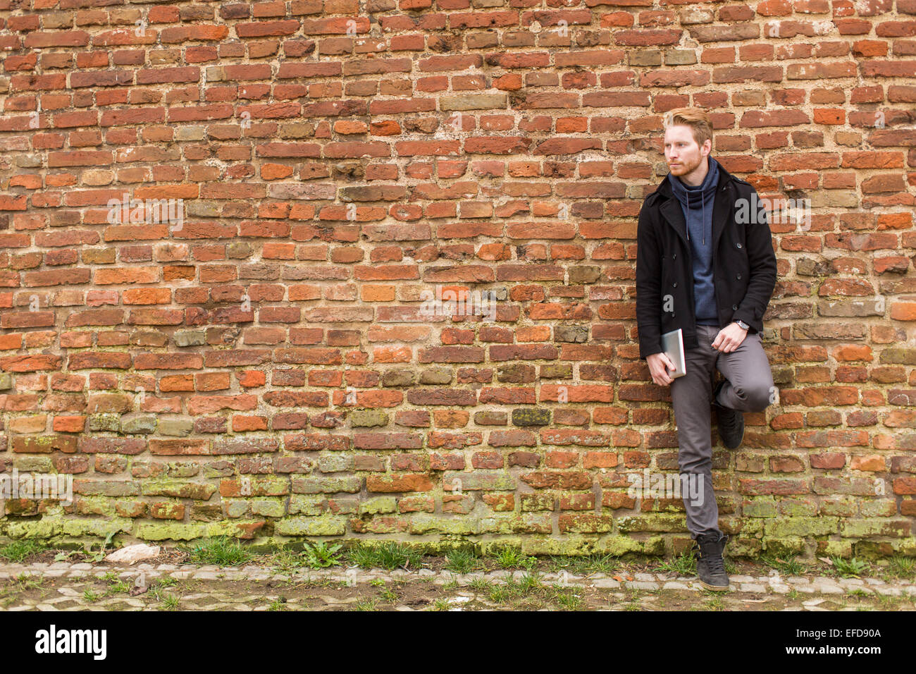 Red brick wall man standing hi-res stock photography and images - Alamy