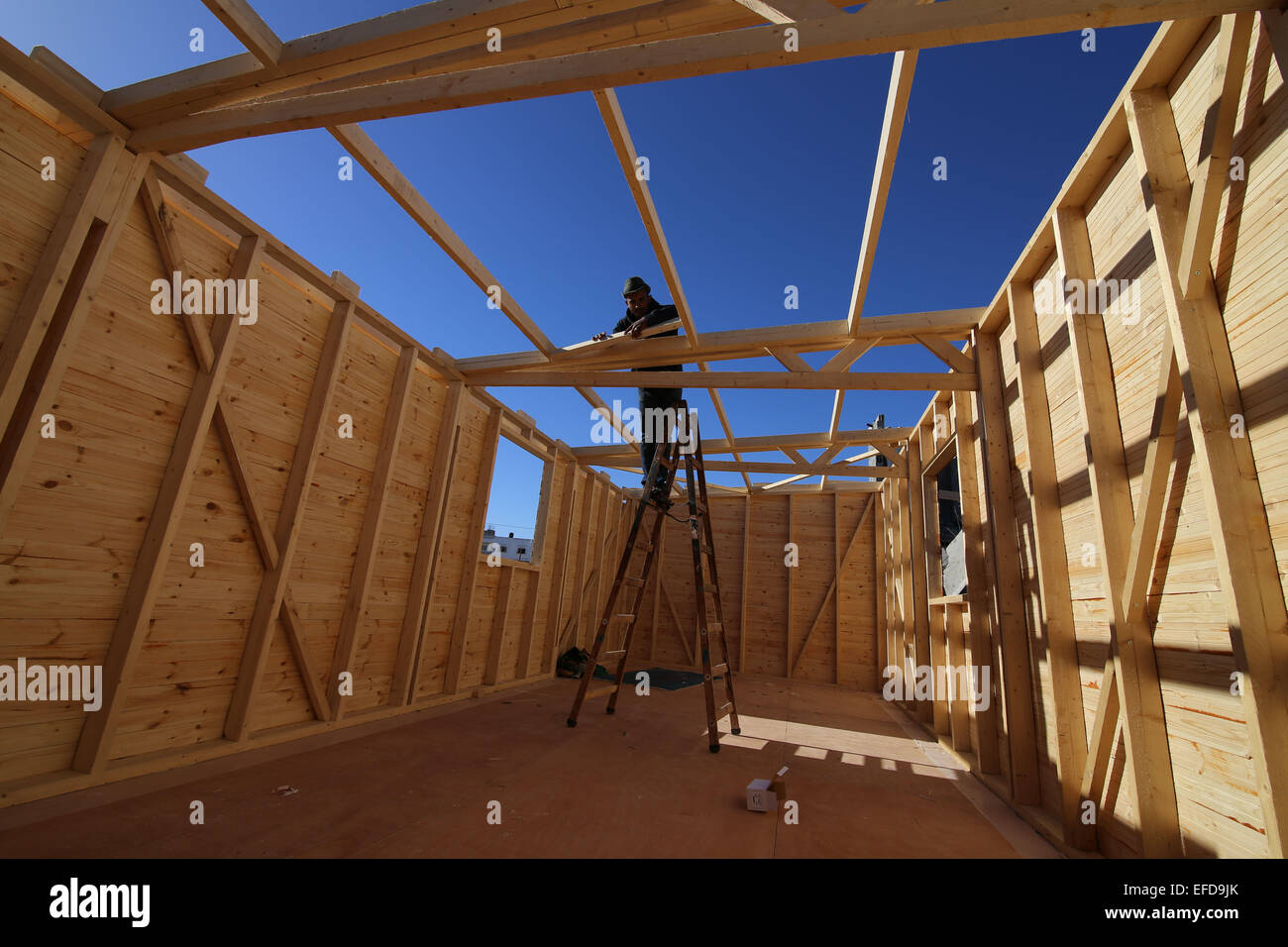 Gaza. 1st Feb, 2015. A Palestinian worker works on building a new wood ...