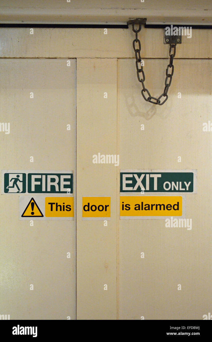 Alarmed fire exit door with signs Stock Photo - Alamy