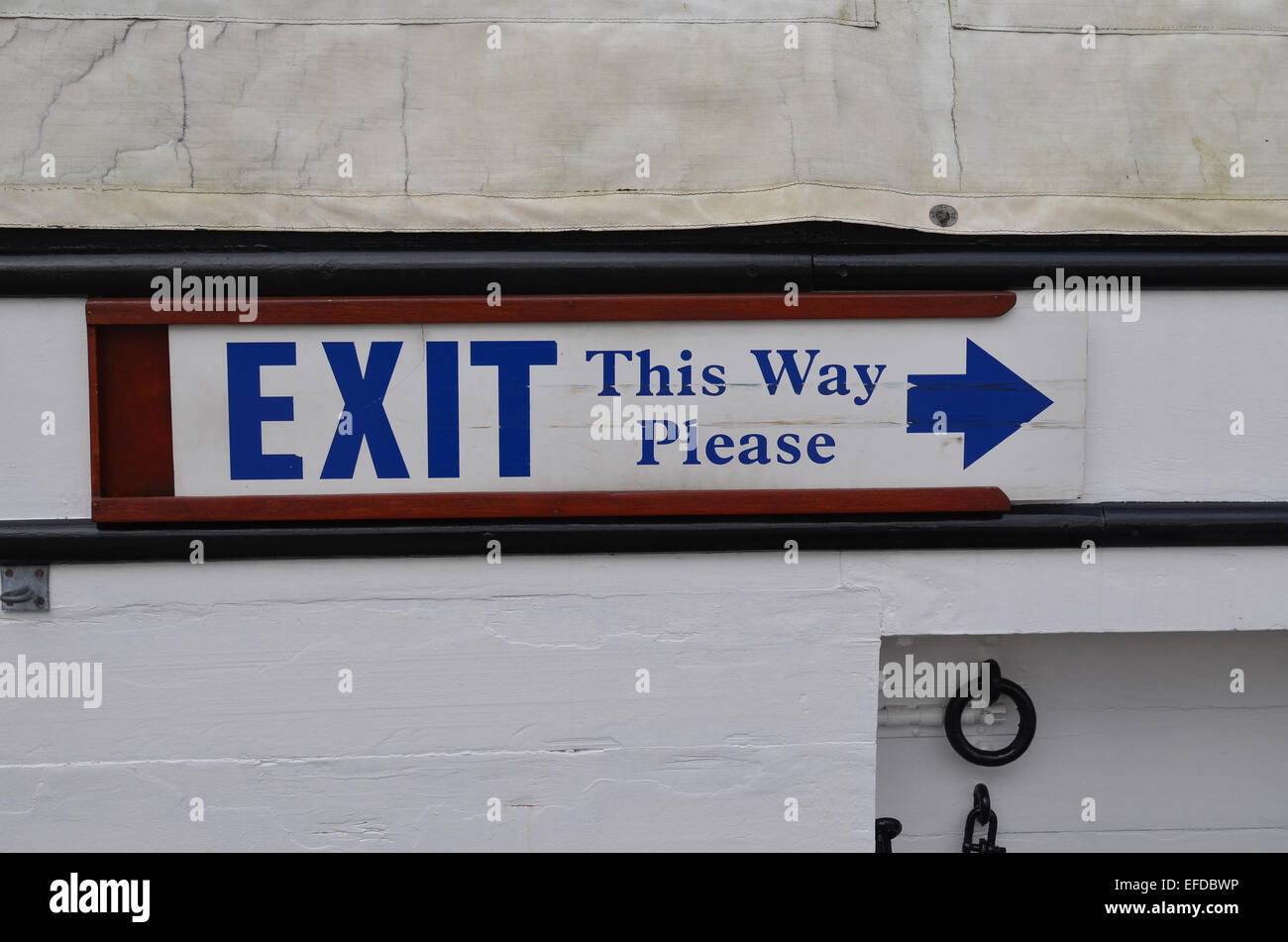 Exit this way please sign with blue text Stock Photo - Alamy