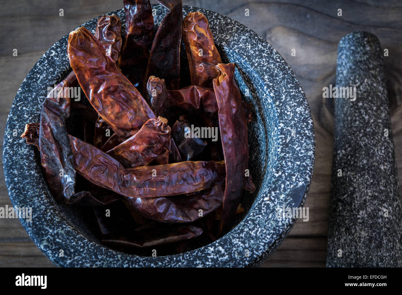 Rustic Chili Peppers in Mortar and Pestle Close up Stock Photo - Alamy