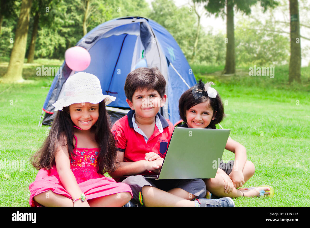 indian children friends park laptop working Stock Photo - Alamy