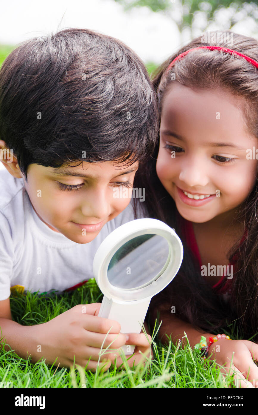 2 indian children friend park Magnifying Glass Searching Stock Photo ...