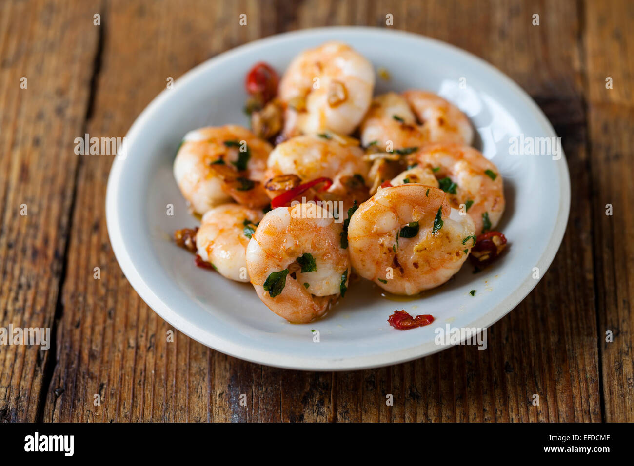 Small plate of spicy prawns Stock Photo - Alamy