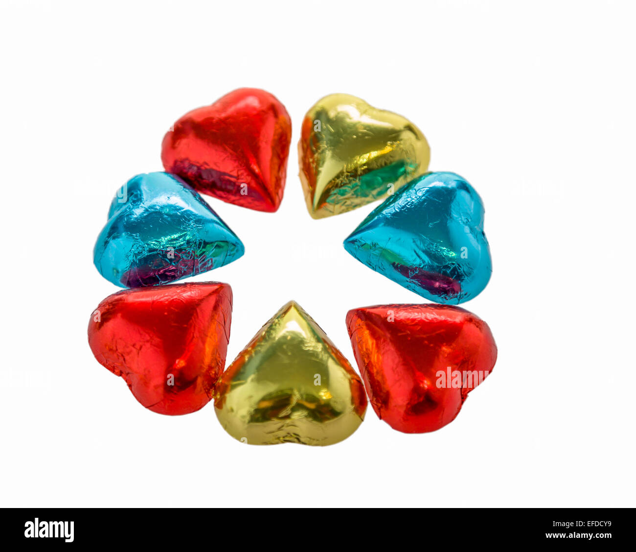 Different colored chocolate hearts forming circle on isolated white ...