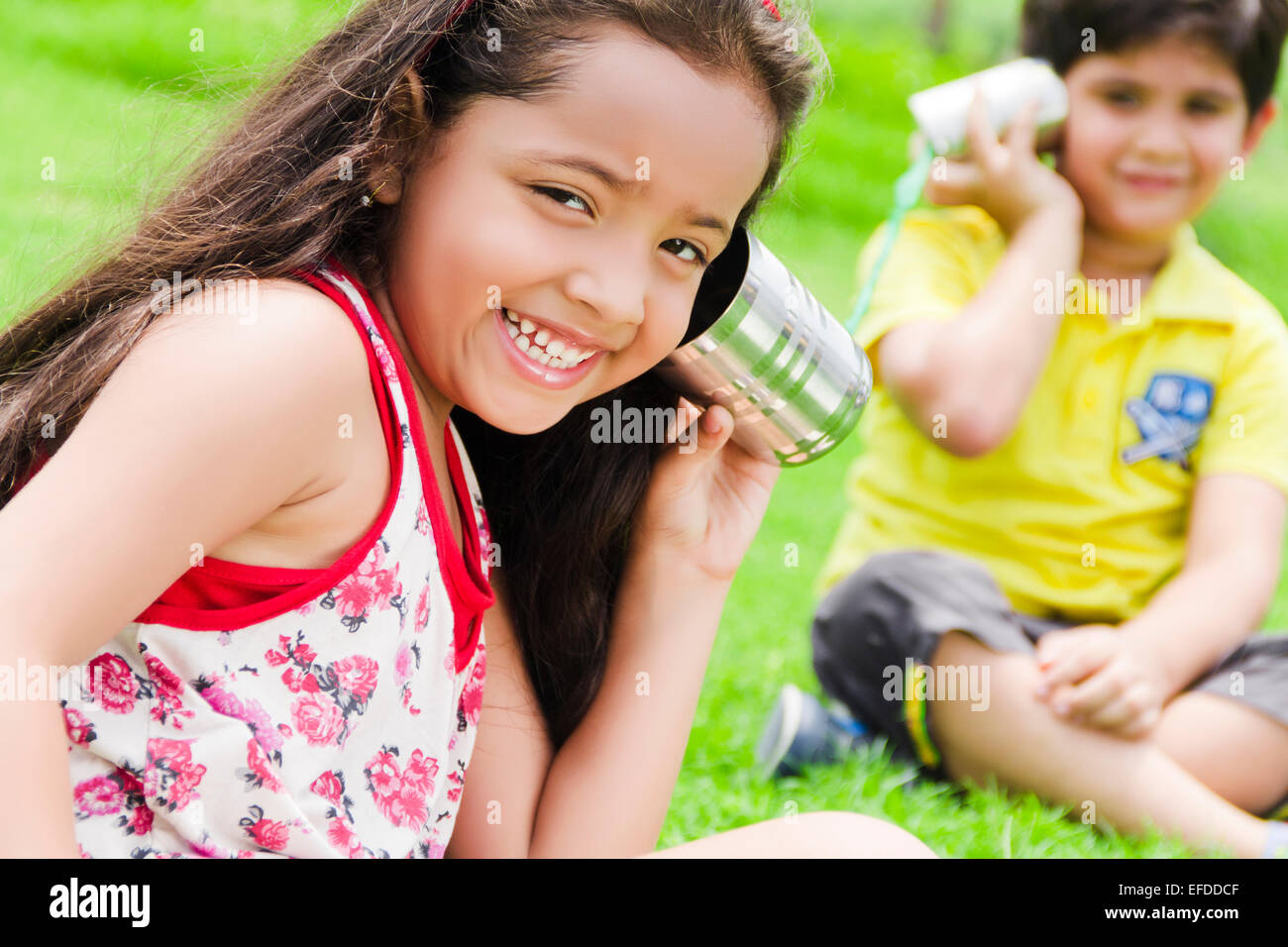 2 indian children friend park toy phone talking Stock Photo - Alamy