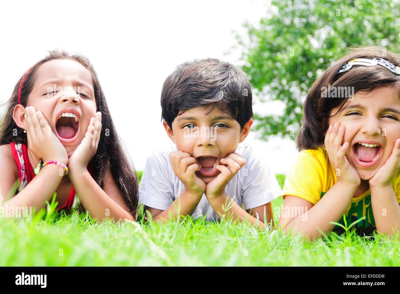 3 indian children friends park fun Stock Photo - Alamy