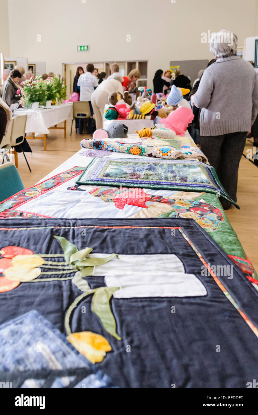 Quilted table cloths on sale at a church jumble sale Stock Photo - Alamy