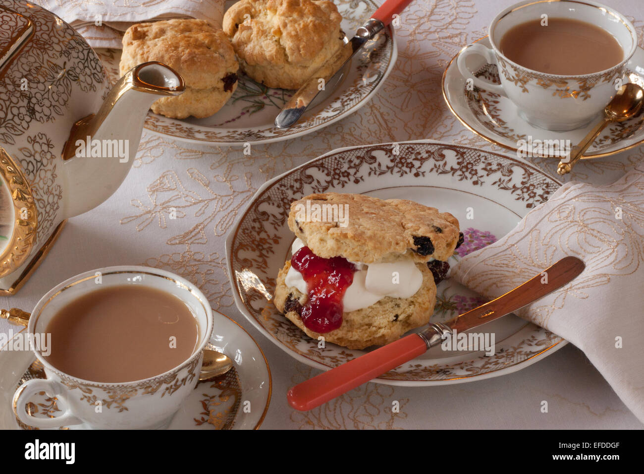A table set for traditional English cream tea. Jam and scones naturally ...