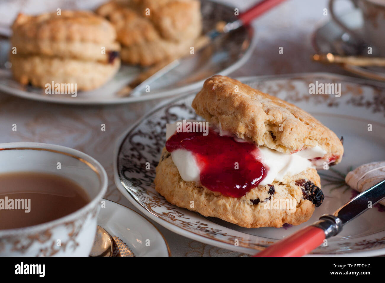 A table set for traditional English cream tea. Jam and scones naturally ...