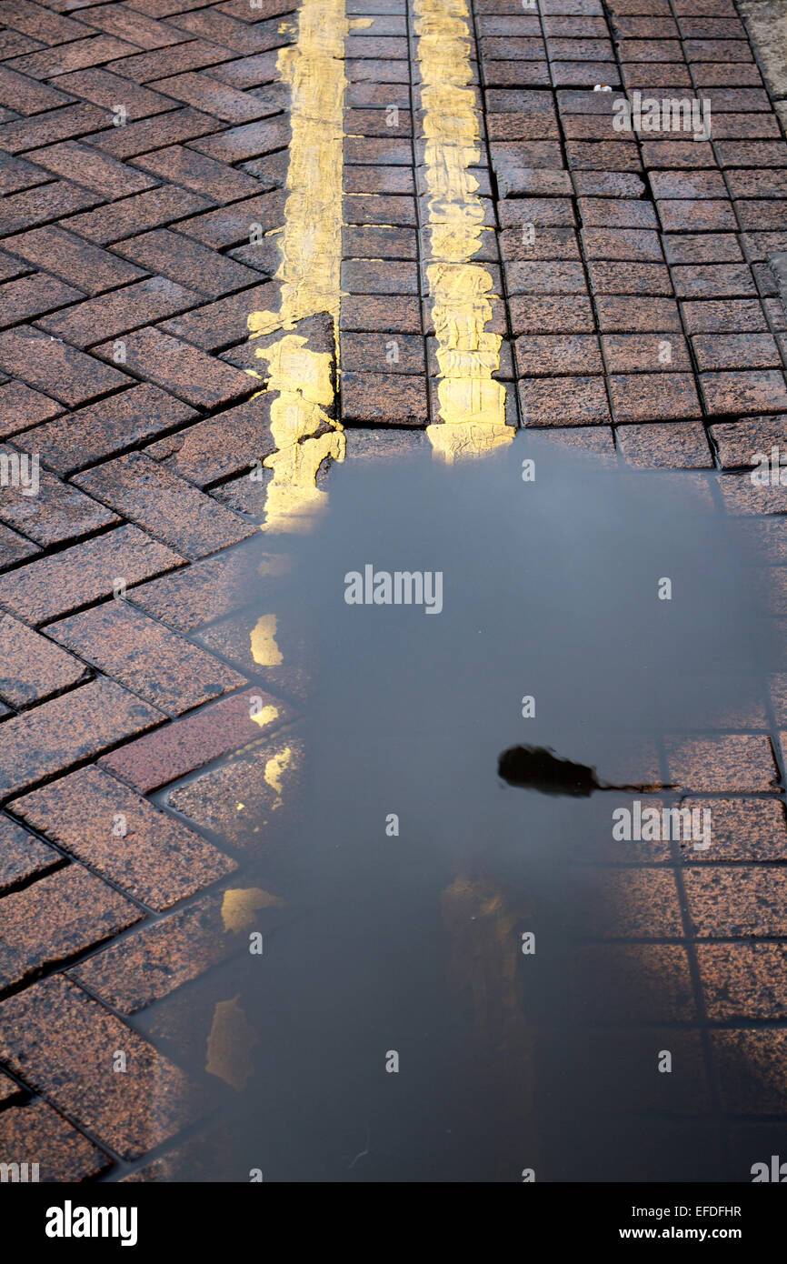A puddle covering double yellow lines, UK Stock Photo - Alamy