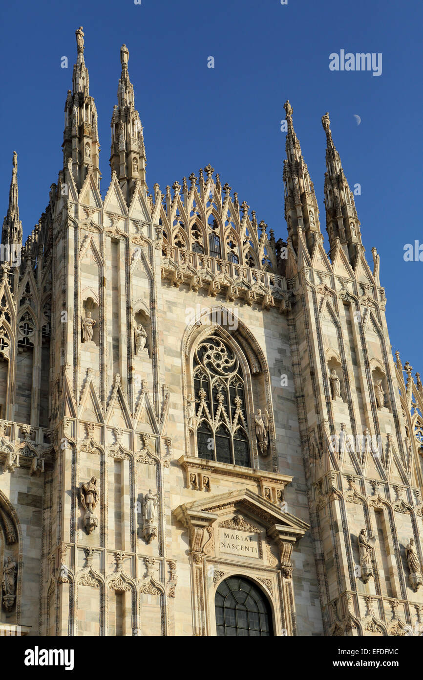 The facade of the cathedral (Duomo) in Milan, Italy. The Gothic style ...