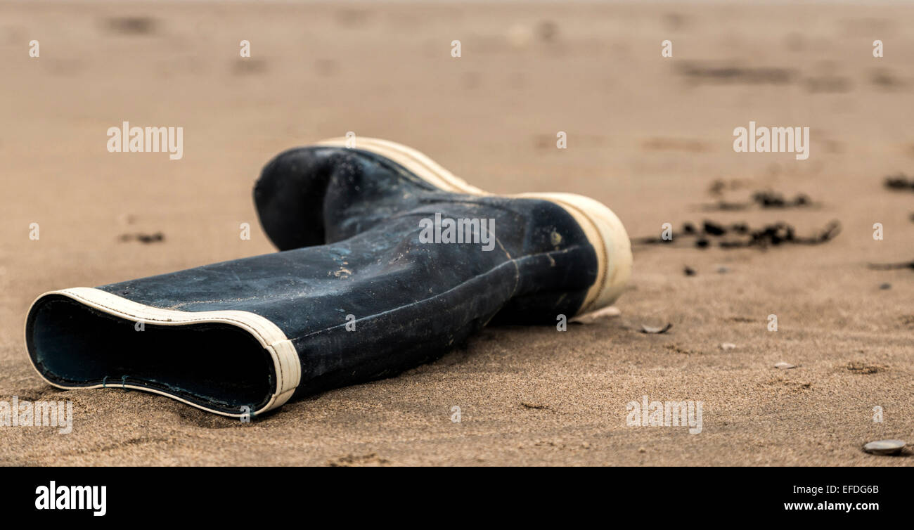 Still life: A gumboot, washed ashore, on the beach at Katwijk aan Zee ...