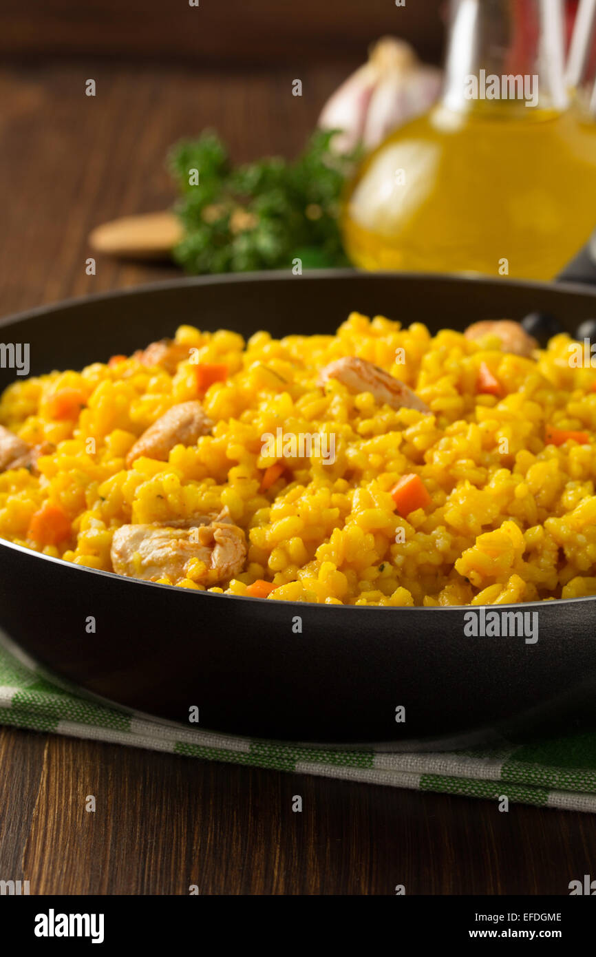 frying pan full of rice on wooden background Stock Photo - Alamy