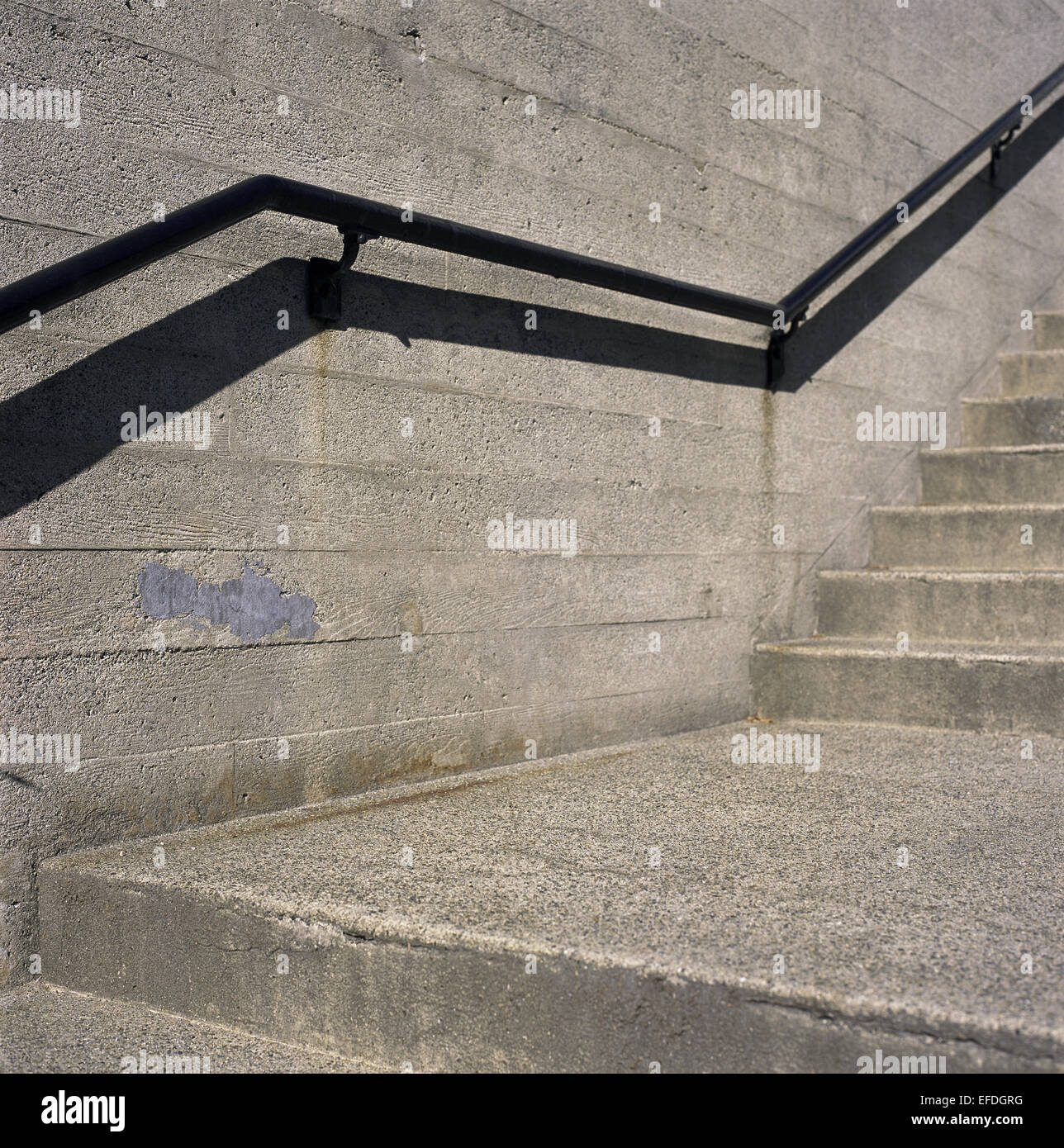 Concrete steps and iron railings with groove concrete wall Stock Photo ...