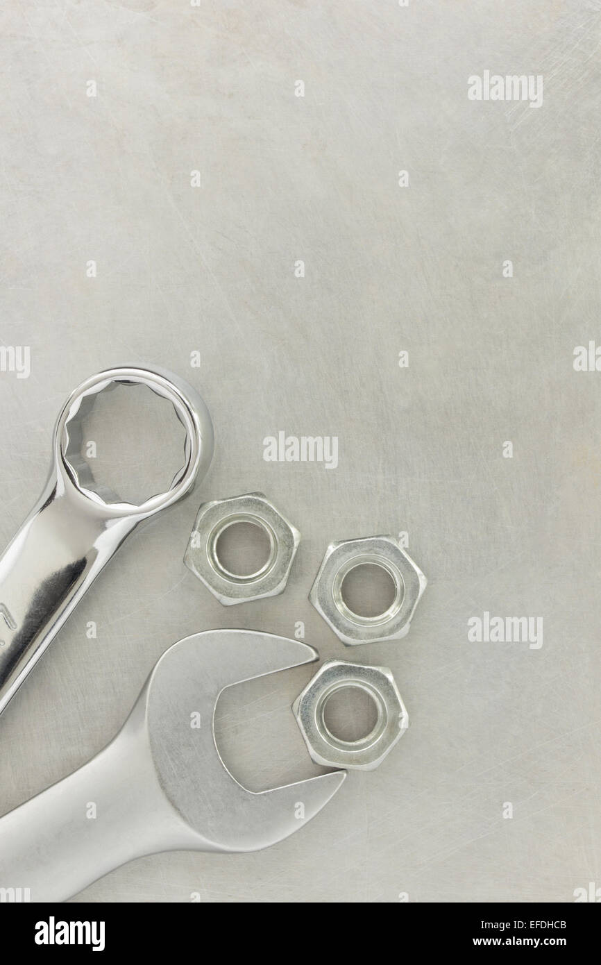wrench tool and nut at metal background Stock Photo - Alamy