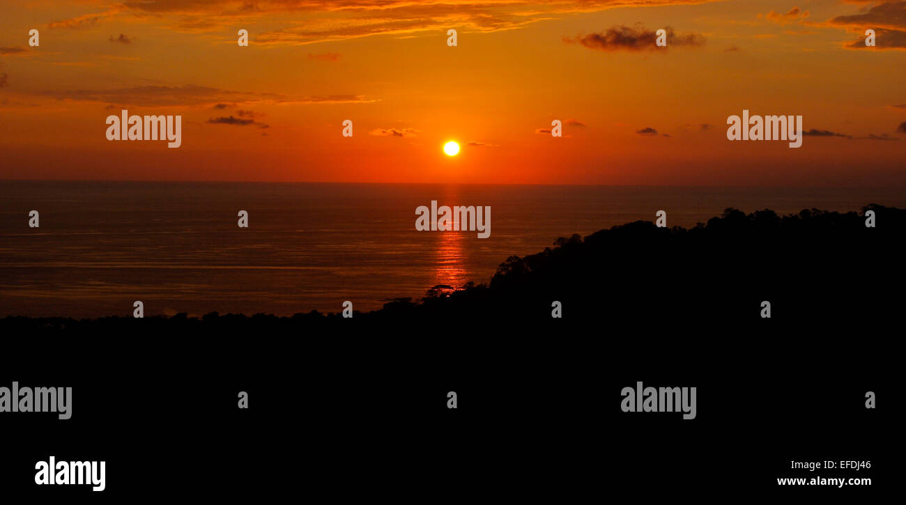 Sunset Over Pacific Ocean with mountain silhouette Stock Photo - Alamy