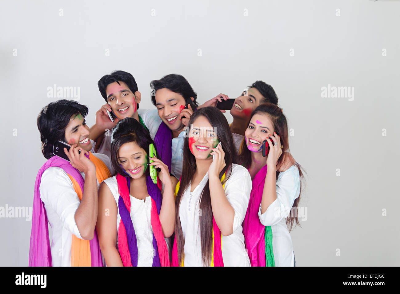 indian friends group Holi Festival talking phone Stock Photo - Alamy