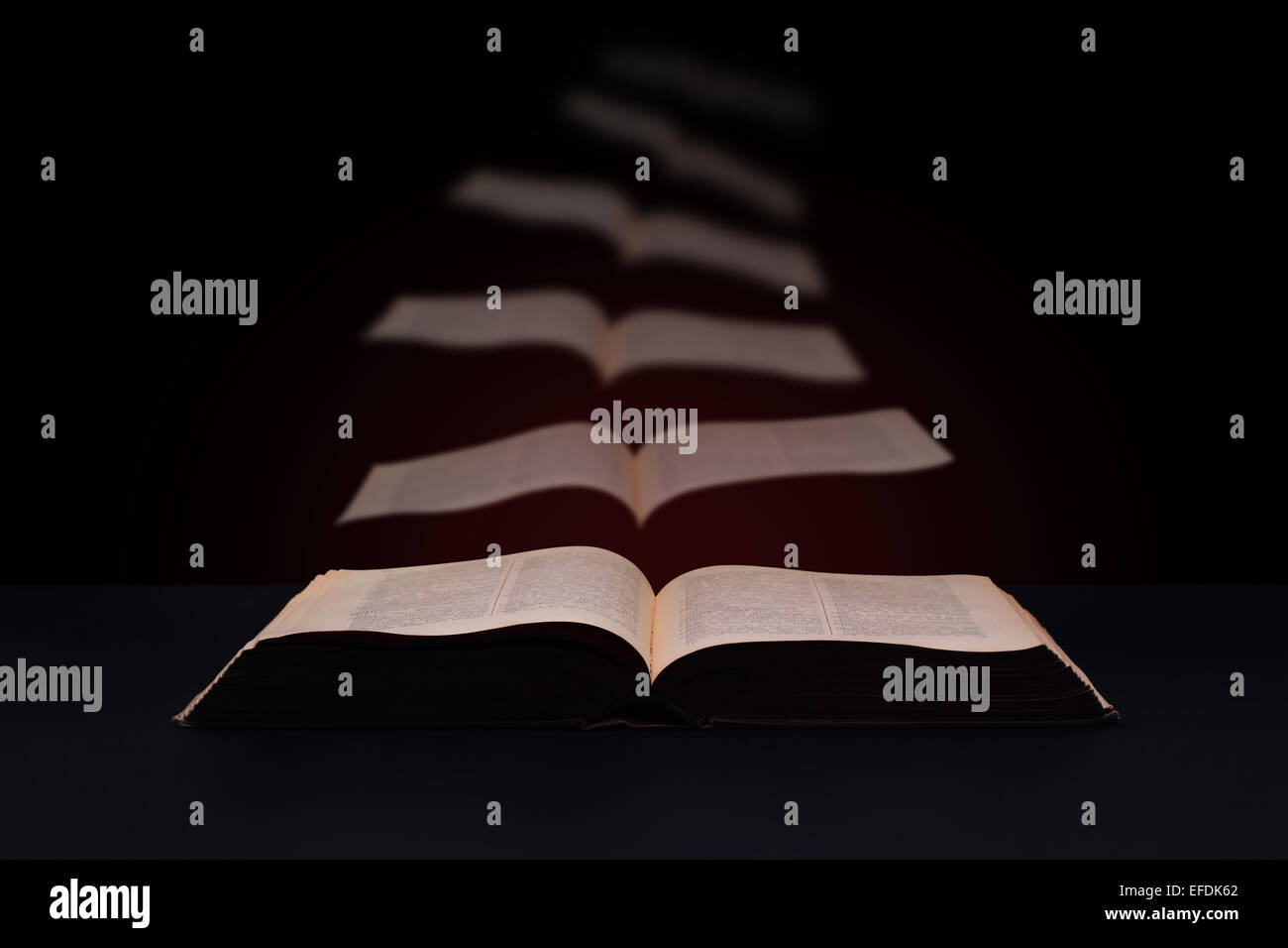 The open old book against a dark background with light shine Stock ...