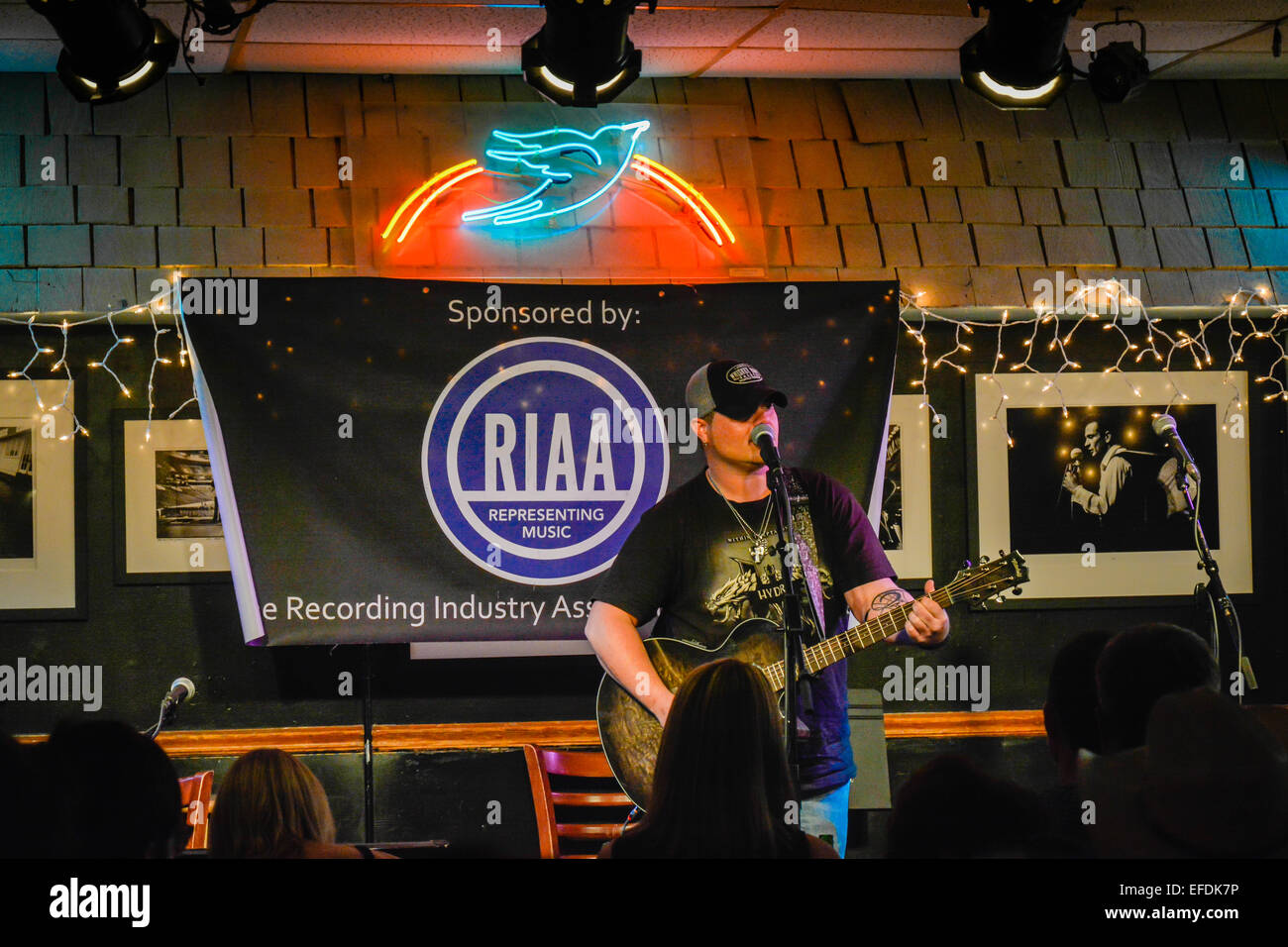 A songwriter gives it their all in a showcase performance with an ...