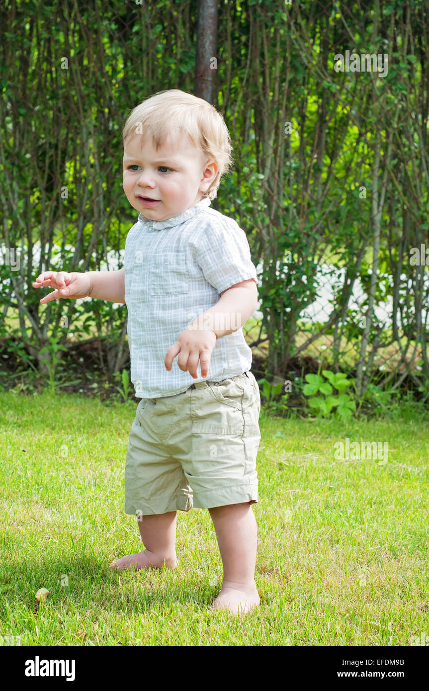 Baby boy doing first steps Stock Photo - Alamy