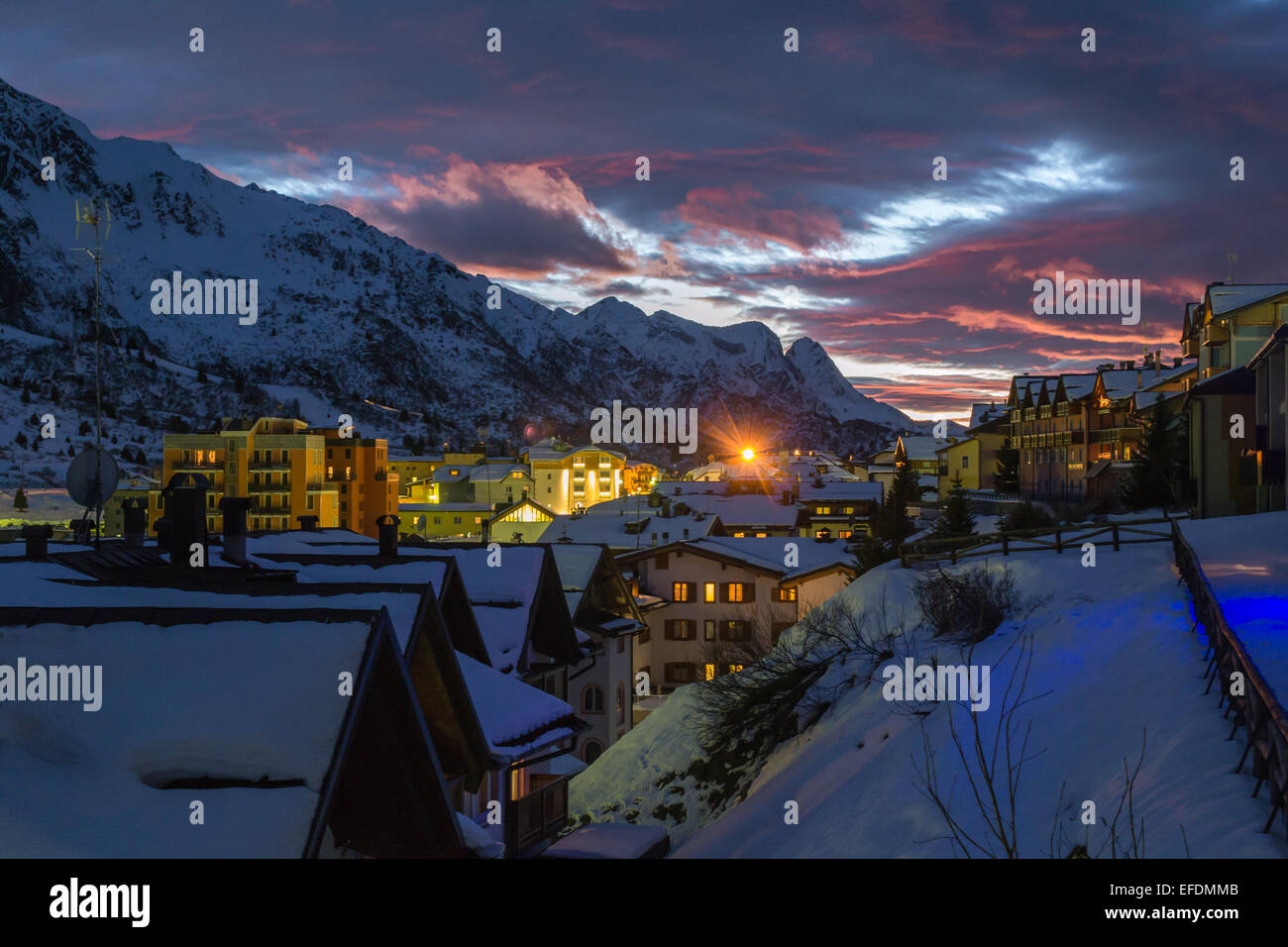 winter sunset in alpine pass village with snow Stock Photo - Alamy