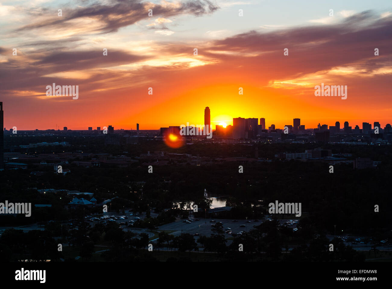 Sunset over city skyline Stock Photo - Alamy