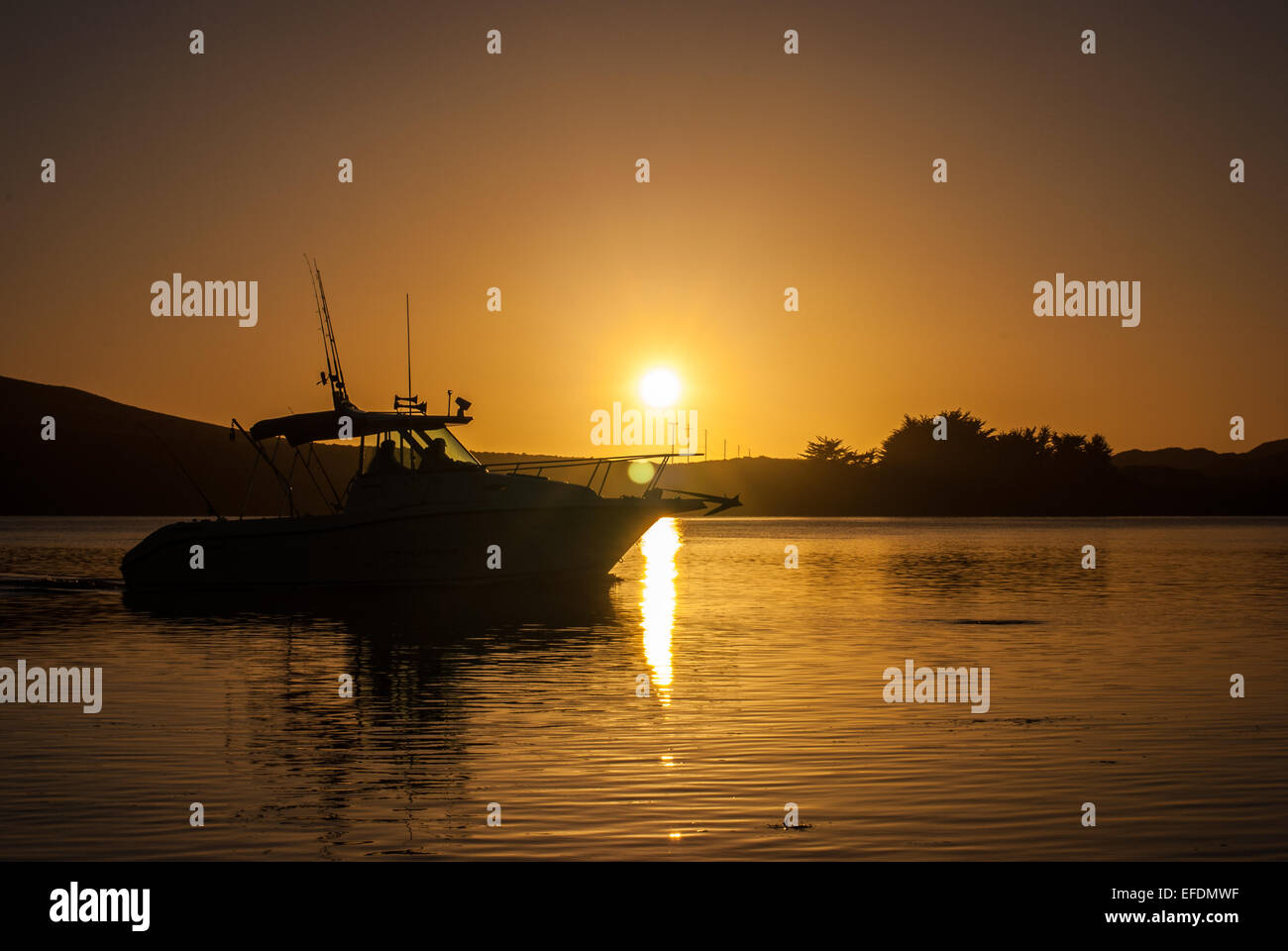 Beautiful sunset with boat Stock Photo - Alamy