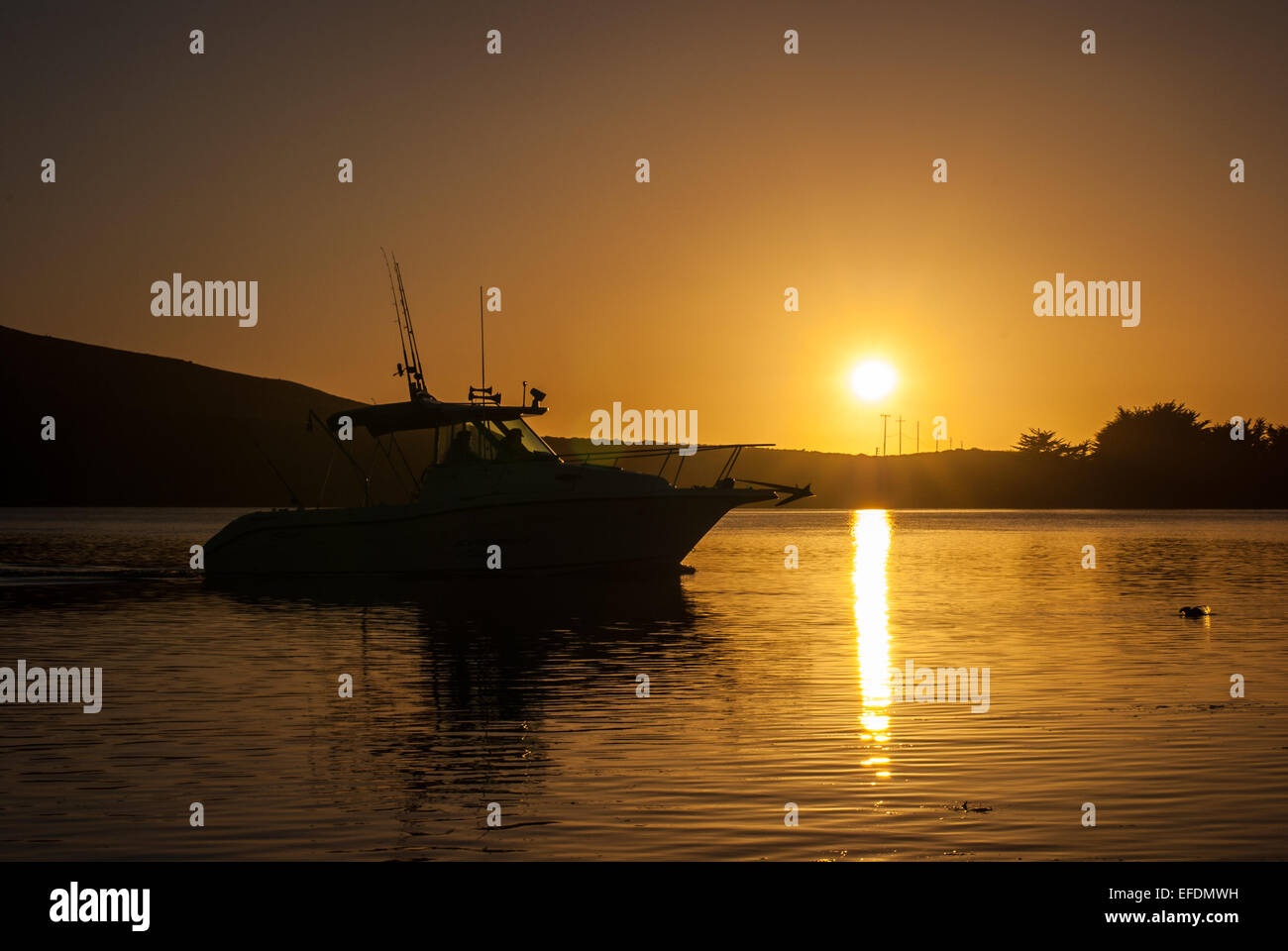 Beautiful sunset with boat Stock Photo - Alamy