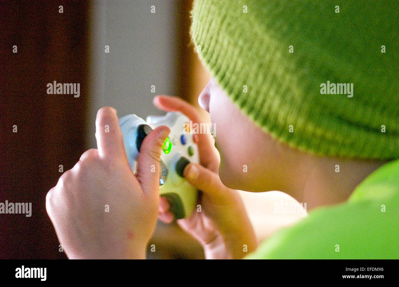 Child playing X-Box or Video game. Playstation Stock Photo - Alamy