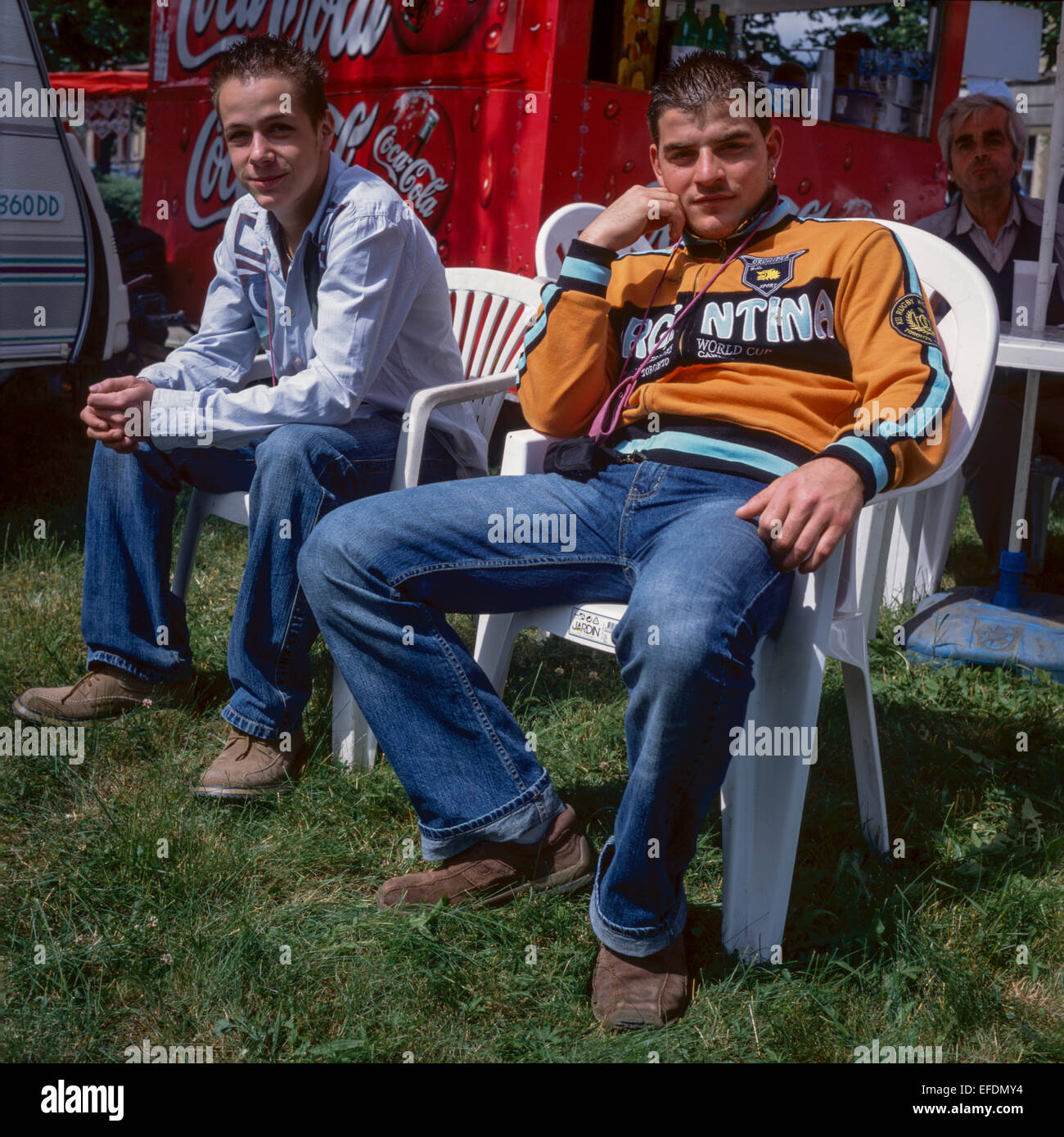 Young men sitting on a plastic chairs, Czech Republic Stock Photo - Alamy